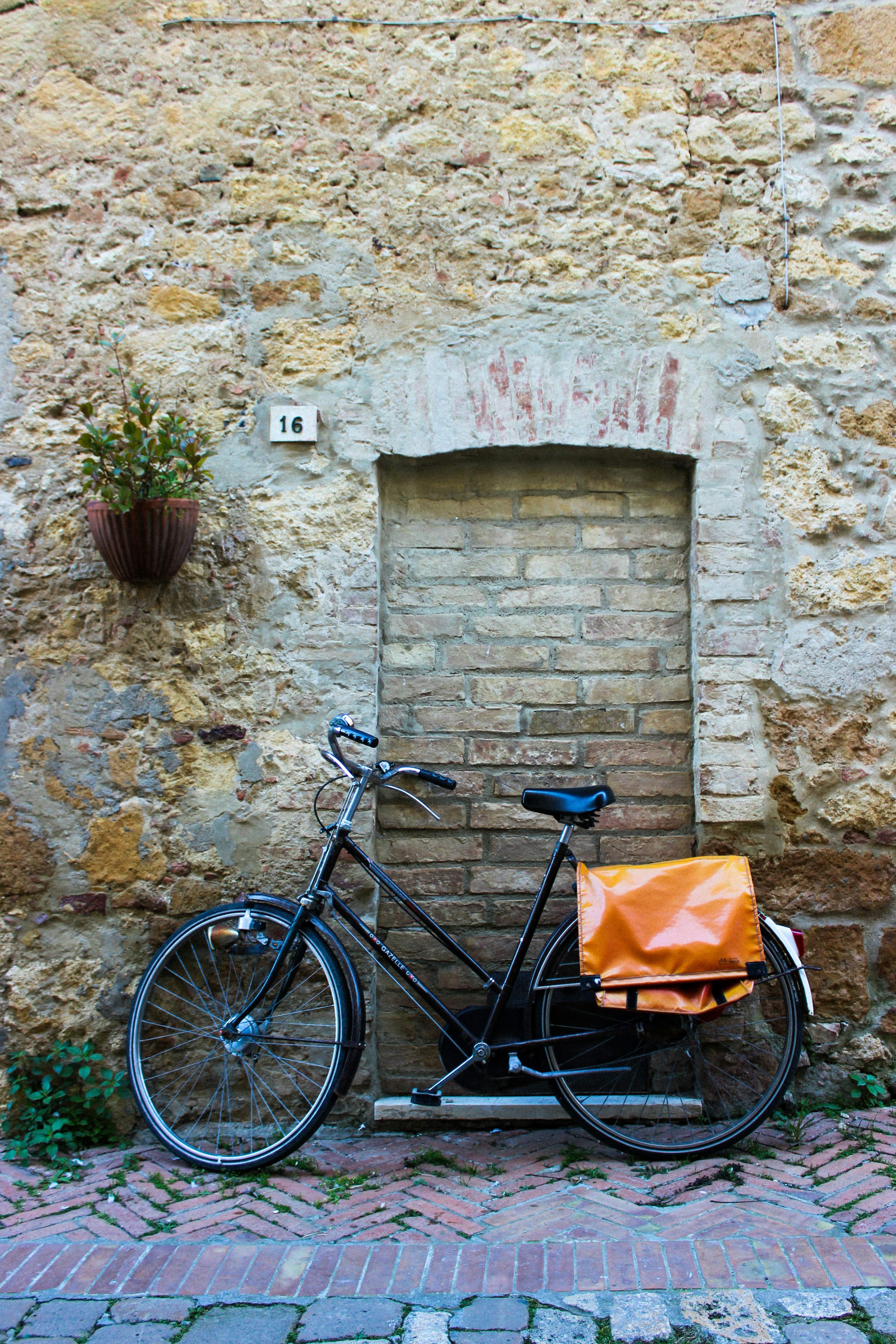 Bike in Front of Stone Doorway with Orange Saddlebag