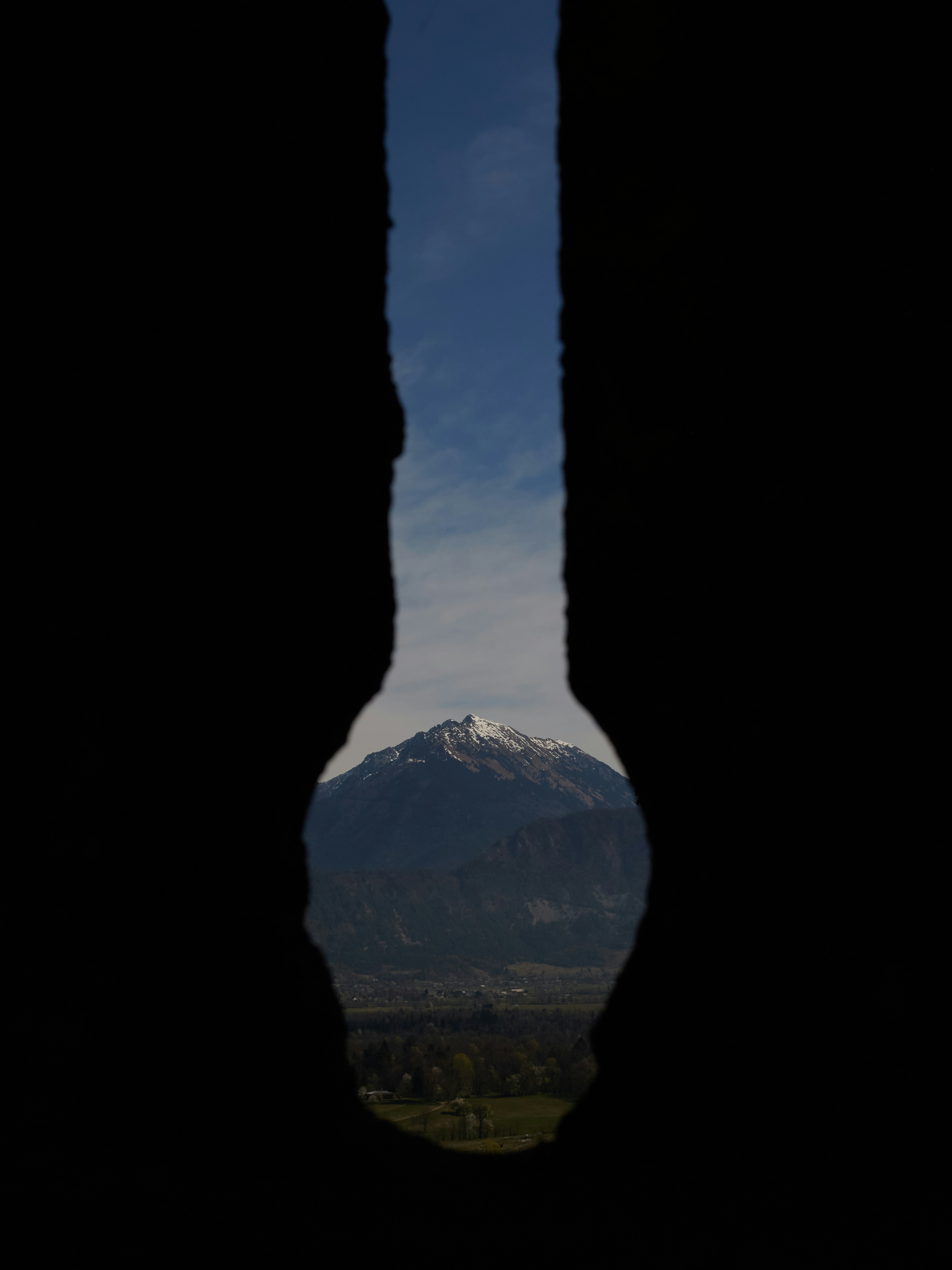 A Narrow Window to the Peaks: Mountain View Through a Silhouette