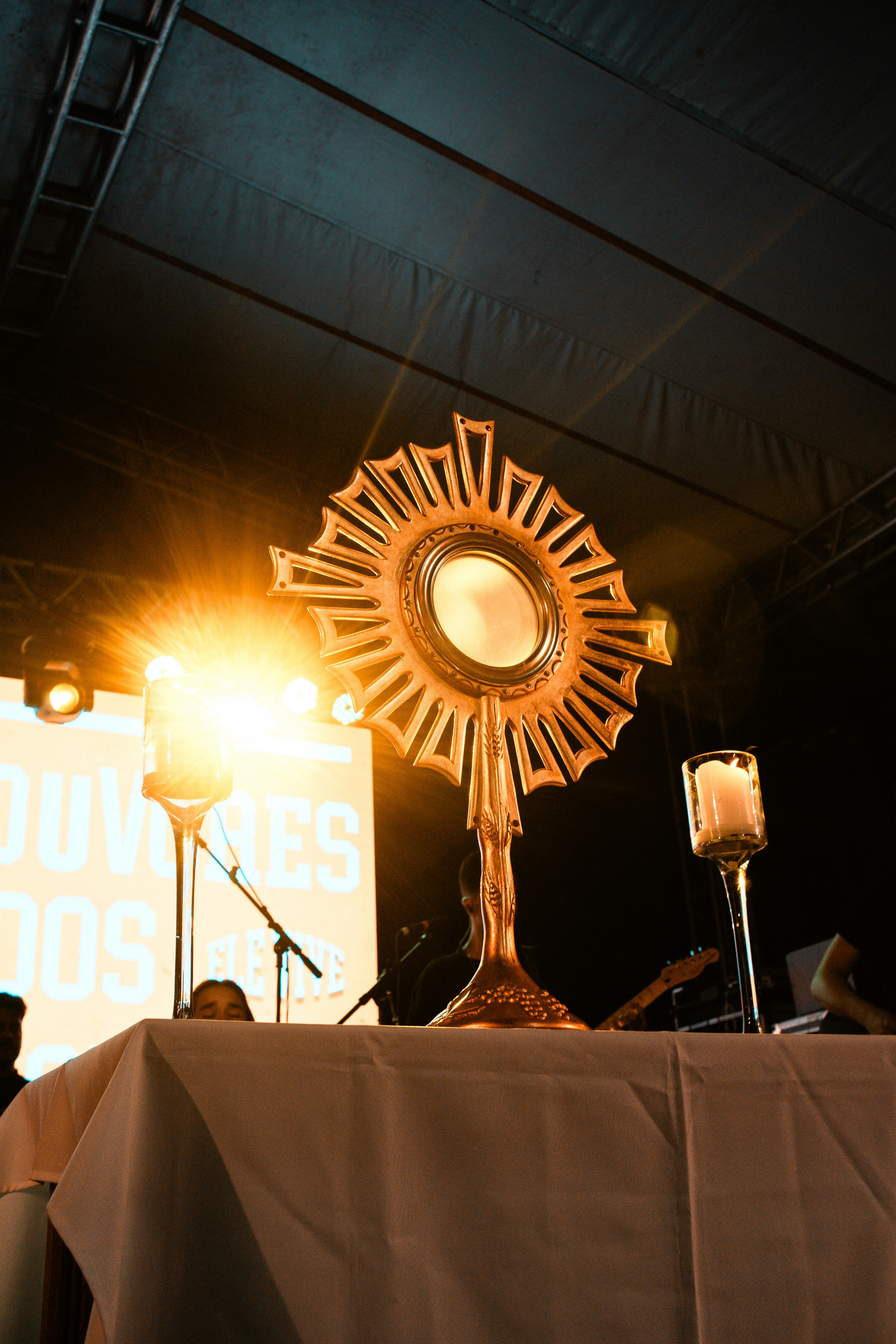Radiant monstrance on stage: sacred centerpiece under warm glow