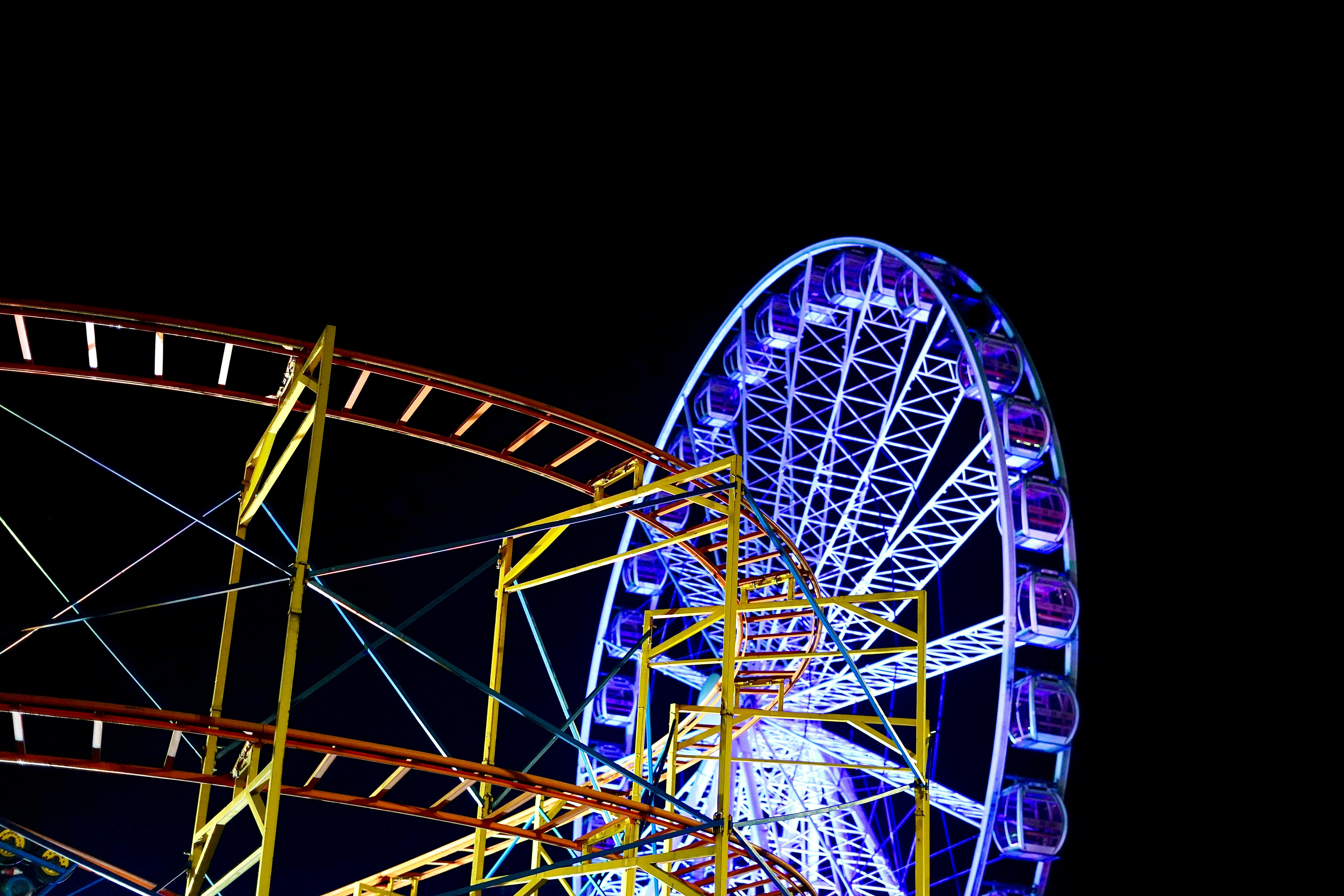 Neon Arc Over Night Ride: Ferris Wheel and Roller Coaster Meet