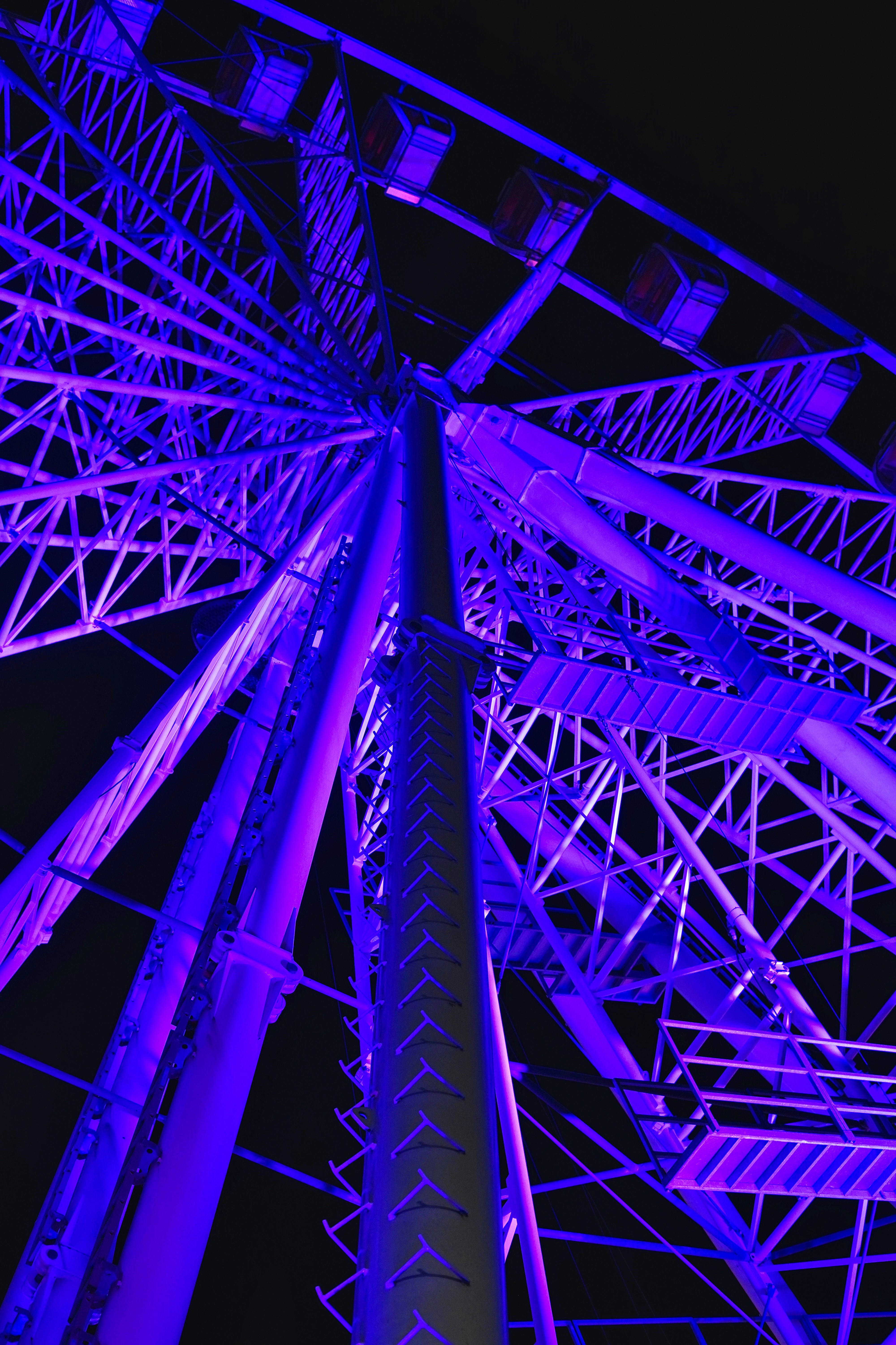 Neon Night Structure: Blue Framework of a Ferris Wheel