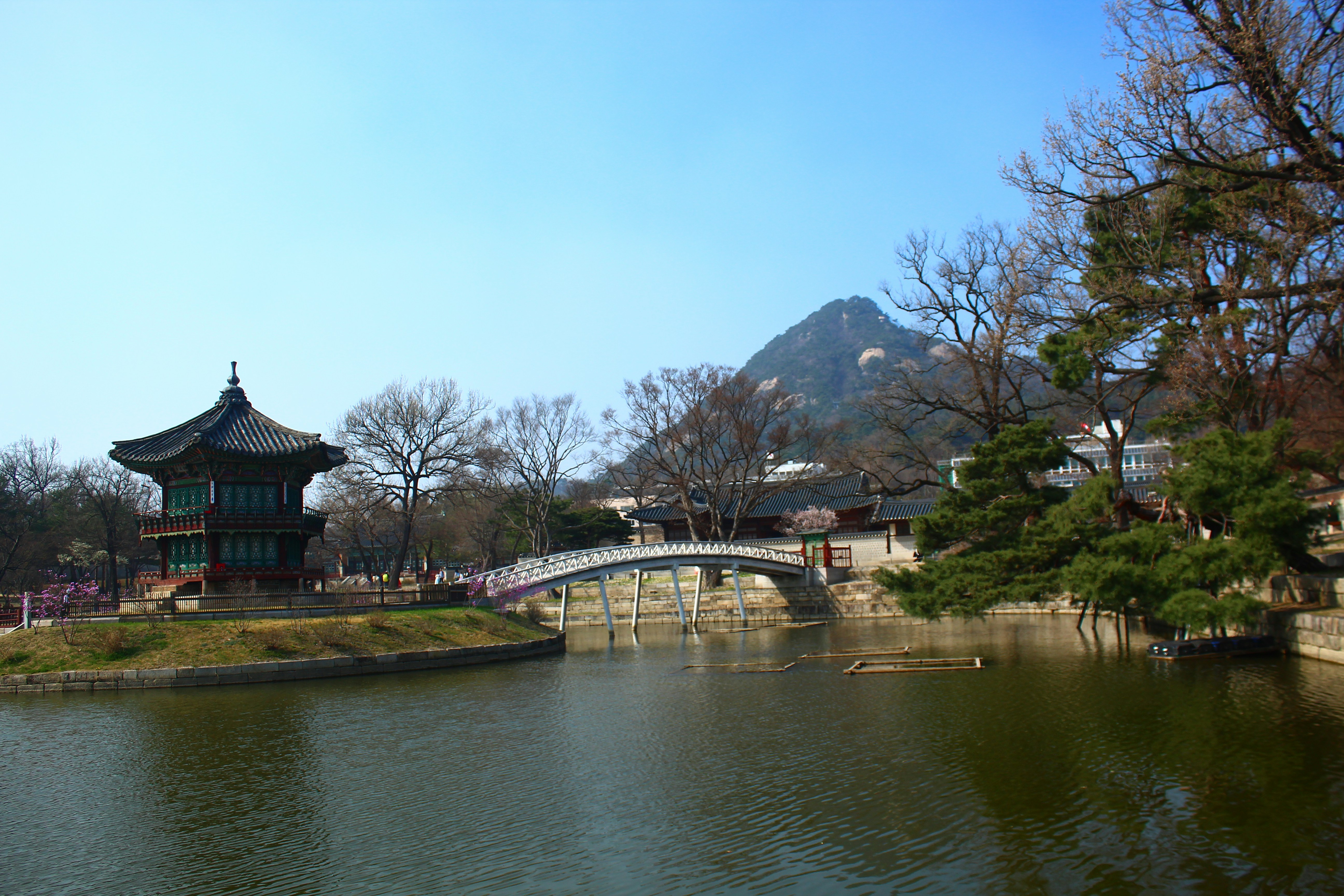 Traditional korean pavilion by a lake with mountains