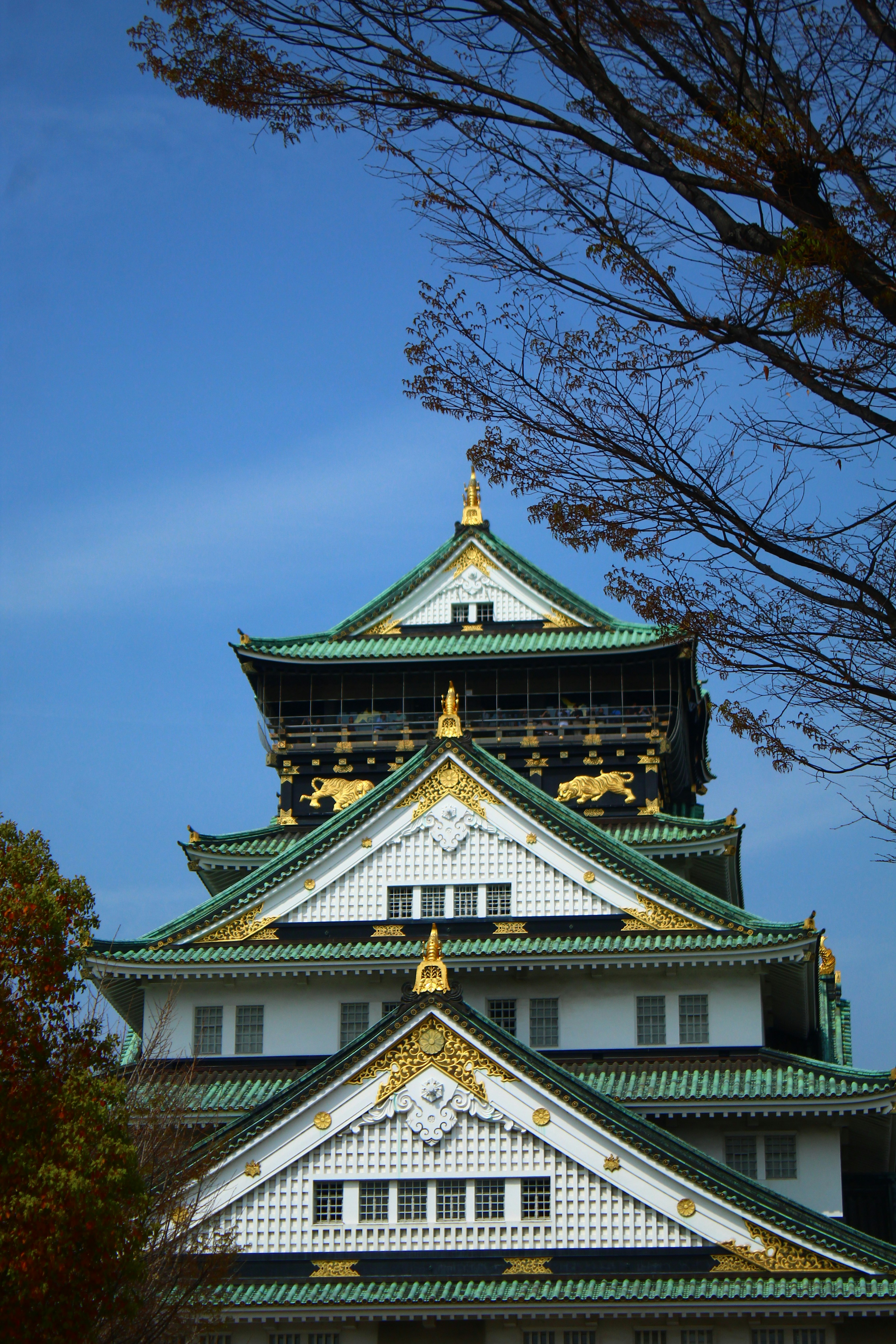 Tiered Majesty: A Tokyo Castle Crowned in Gold Beneath a Spring Sky