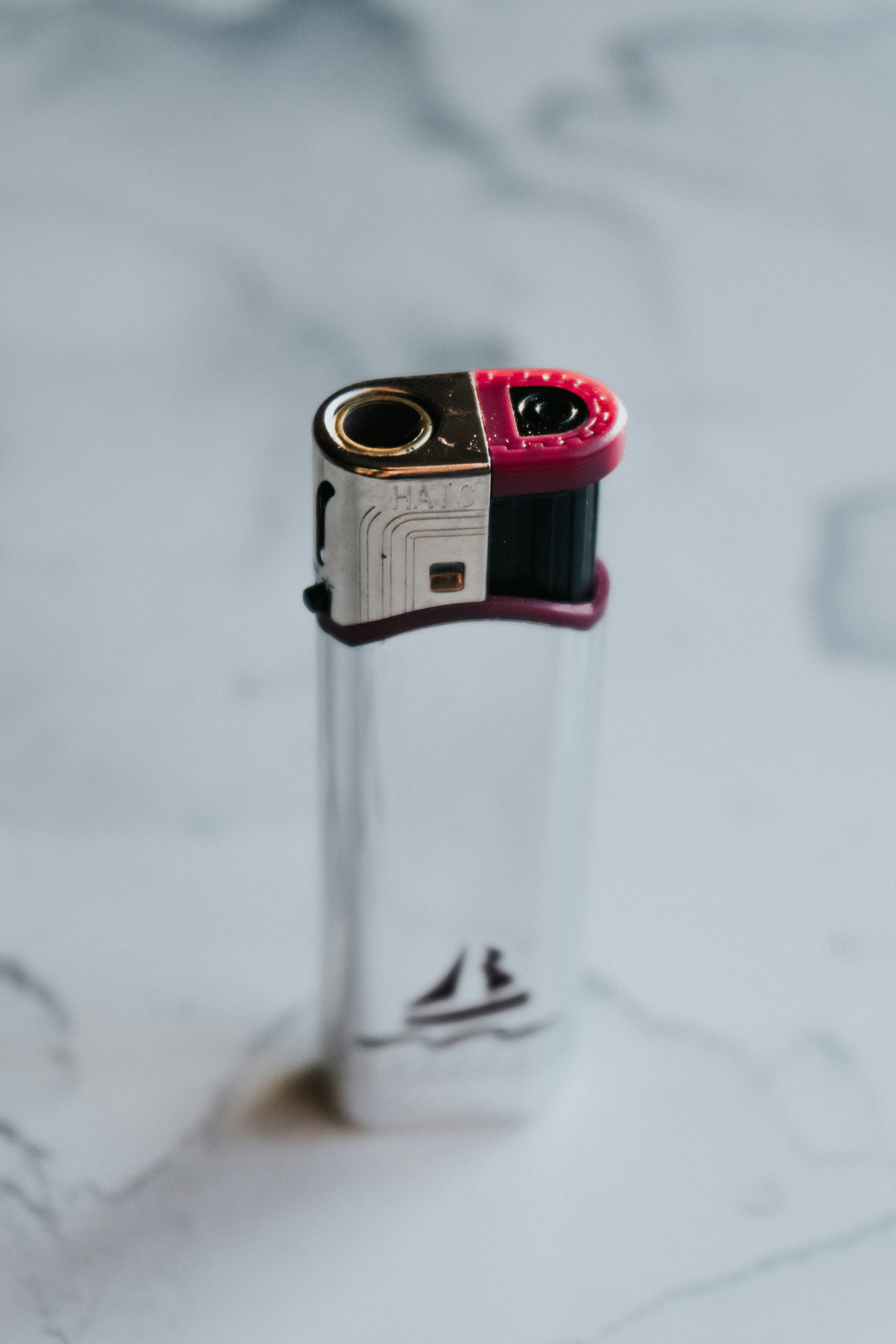 Inverted Flame: A Close-Up of a Pocket Lighter in Frosted Light