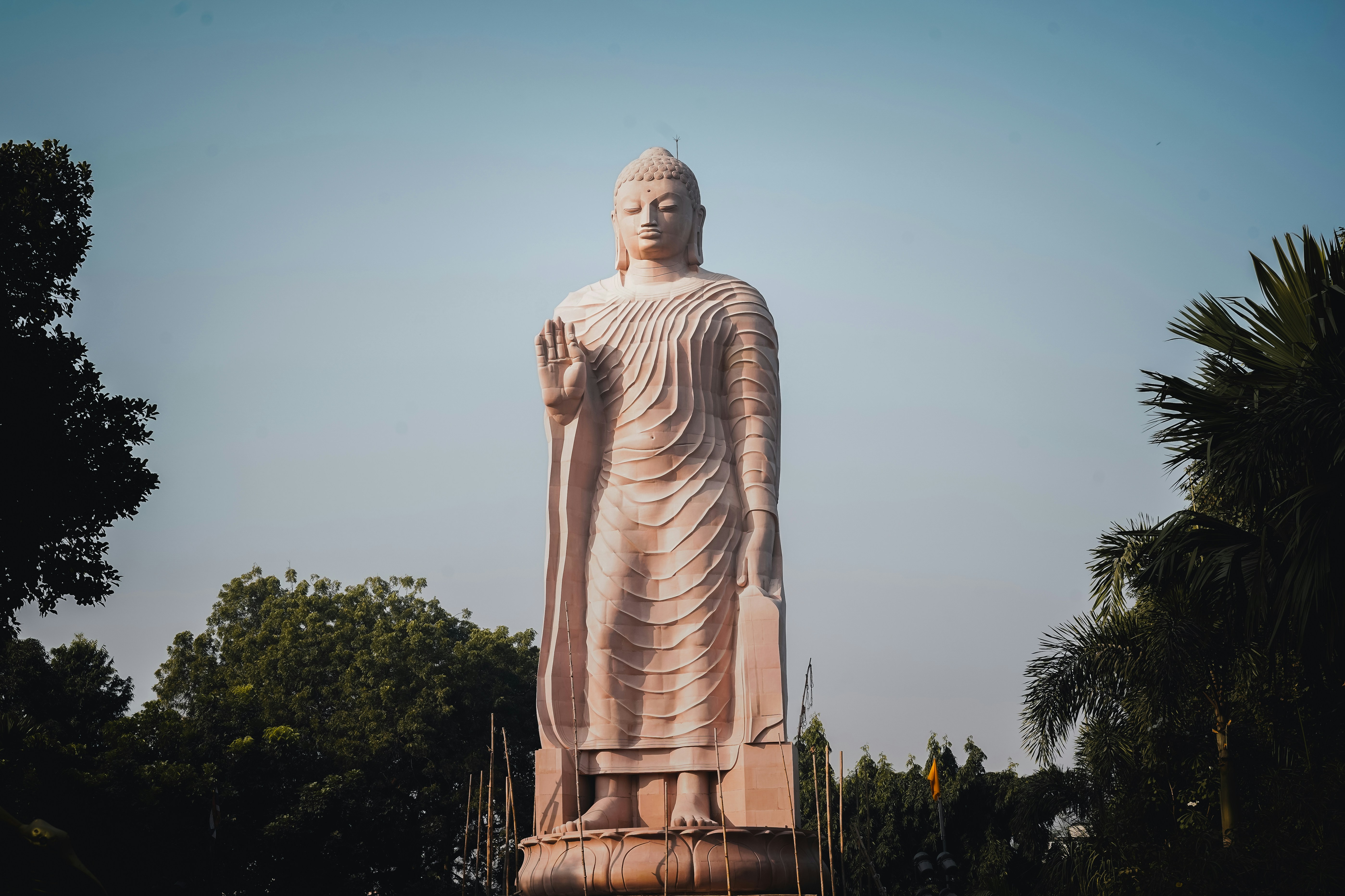Serene Giant: A Buddha Statue Reaches Toward Calm Skies