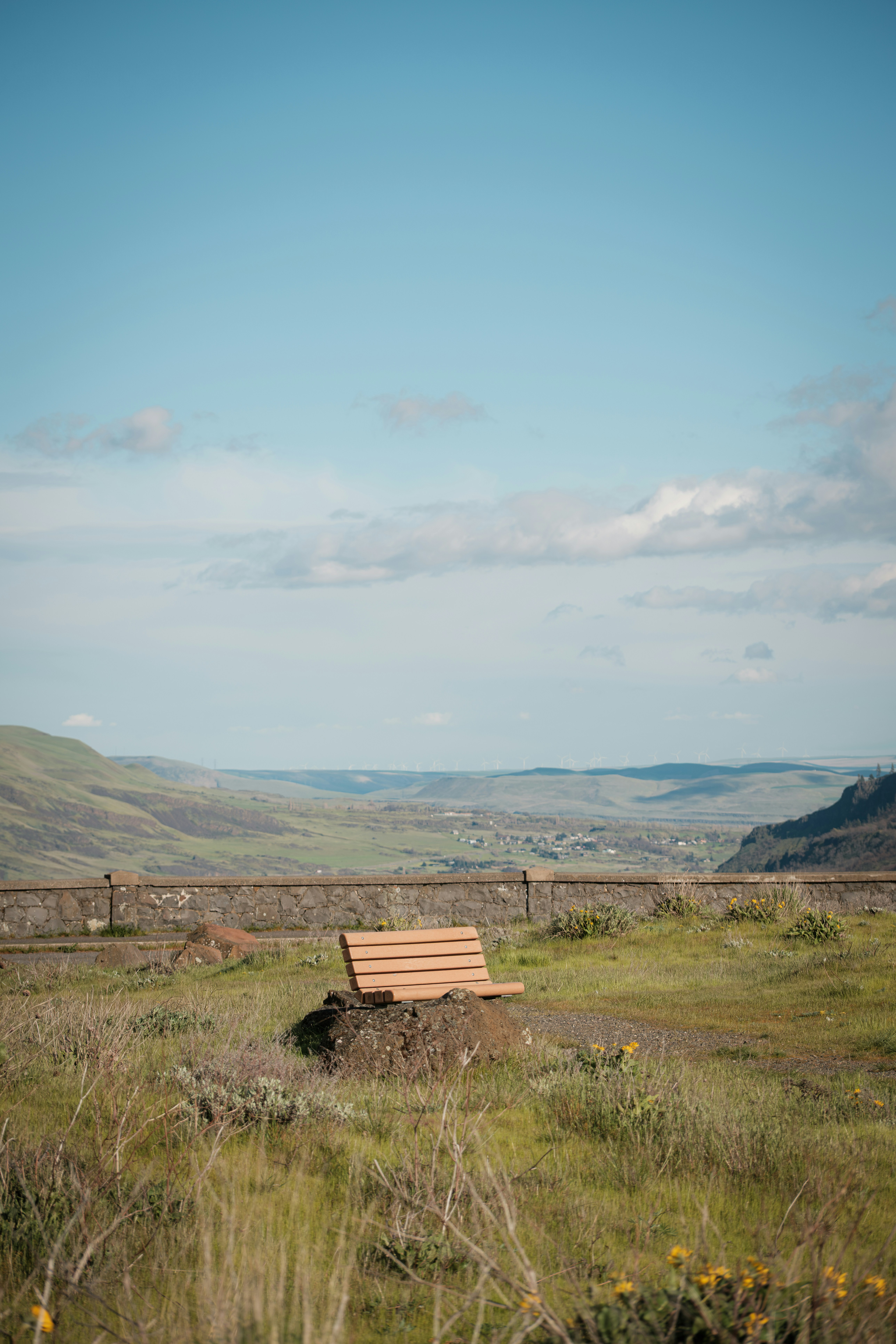 Bench at the Edge: A Quiet Vista Over Rolling Hills