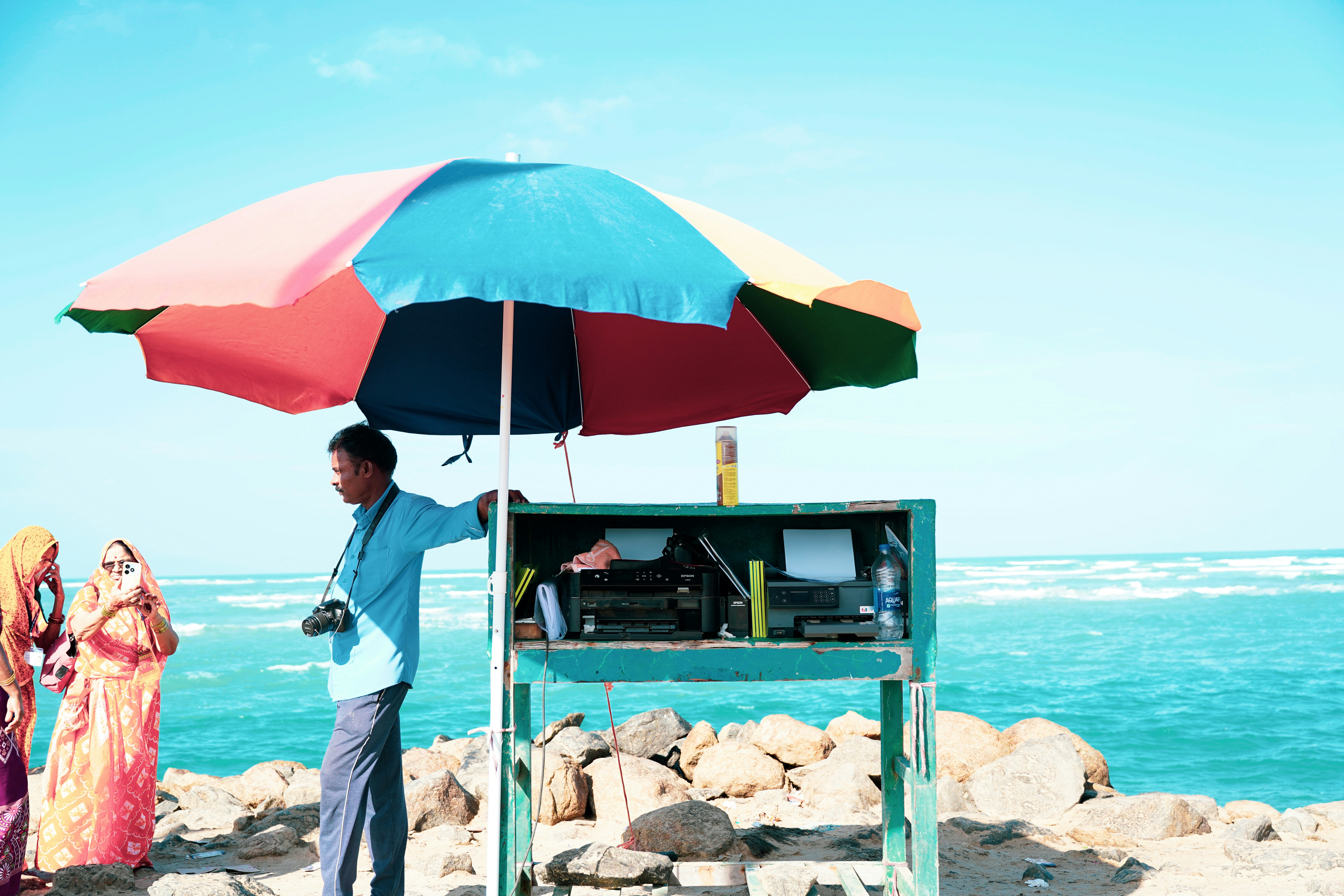 Coastal Café: Umbrella and Steam Amid Sea Breeze