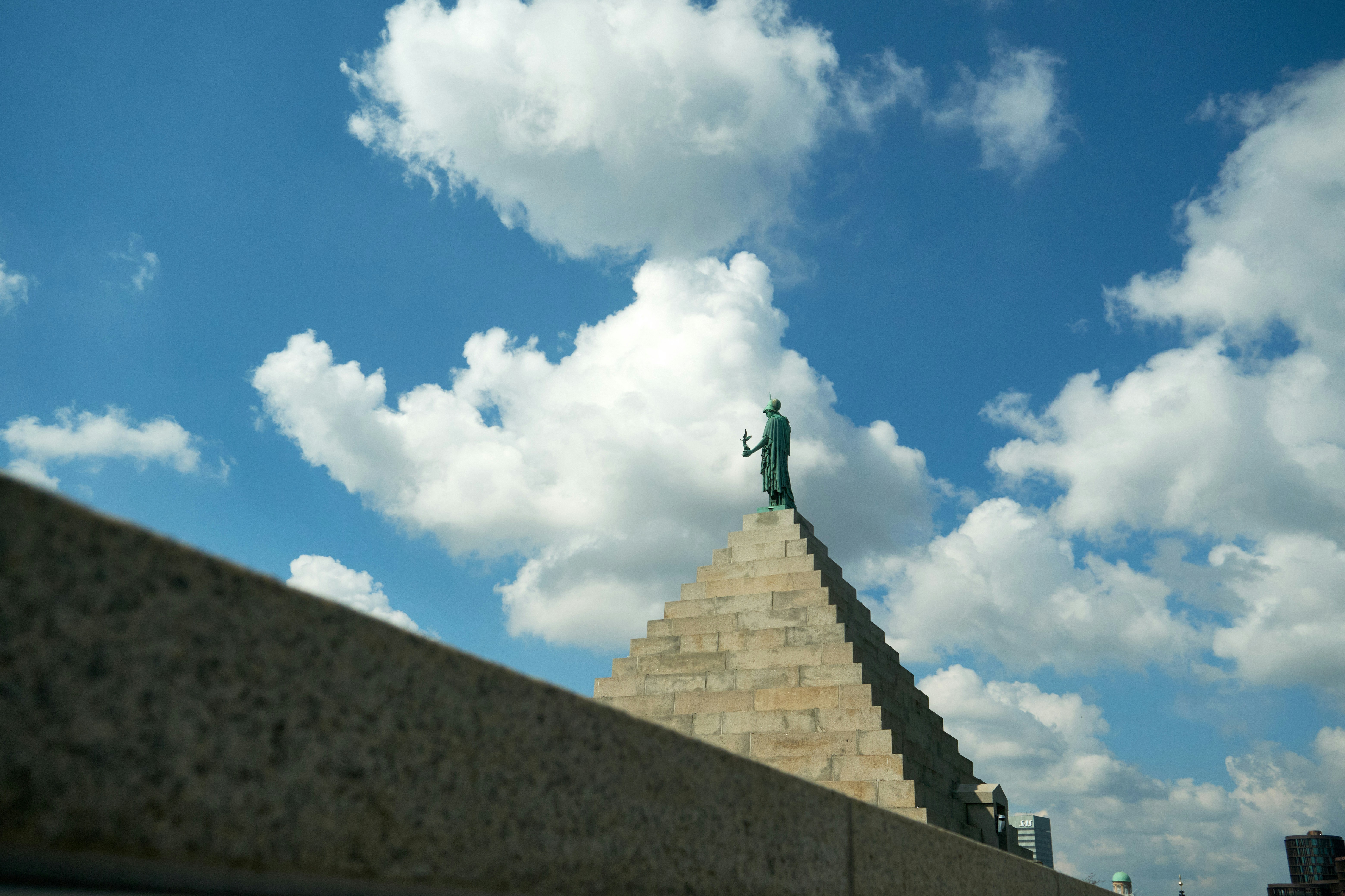 Statue on a Pyramid: A Skyward Moment Above Stone Ramps