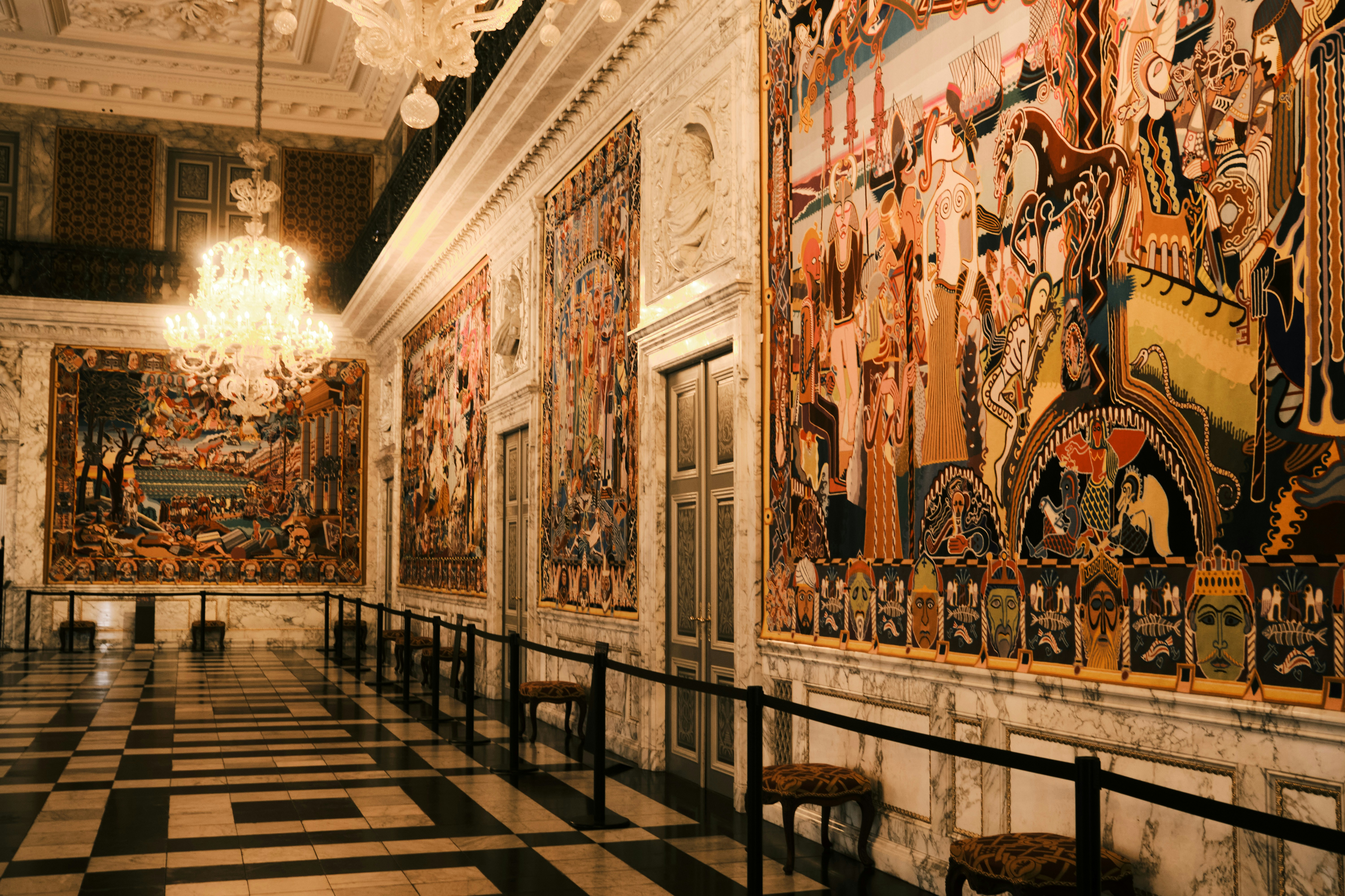 Ornate Gallery Hall: Tapestry Walls and Lantern Light