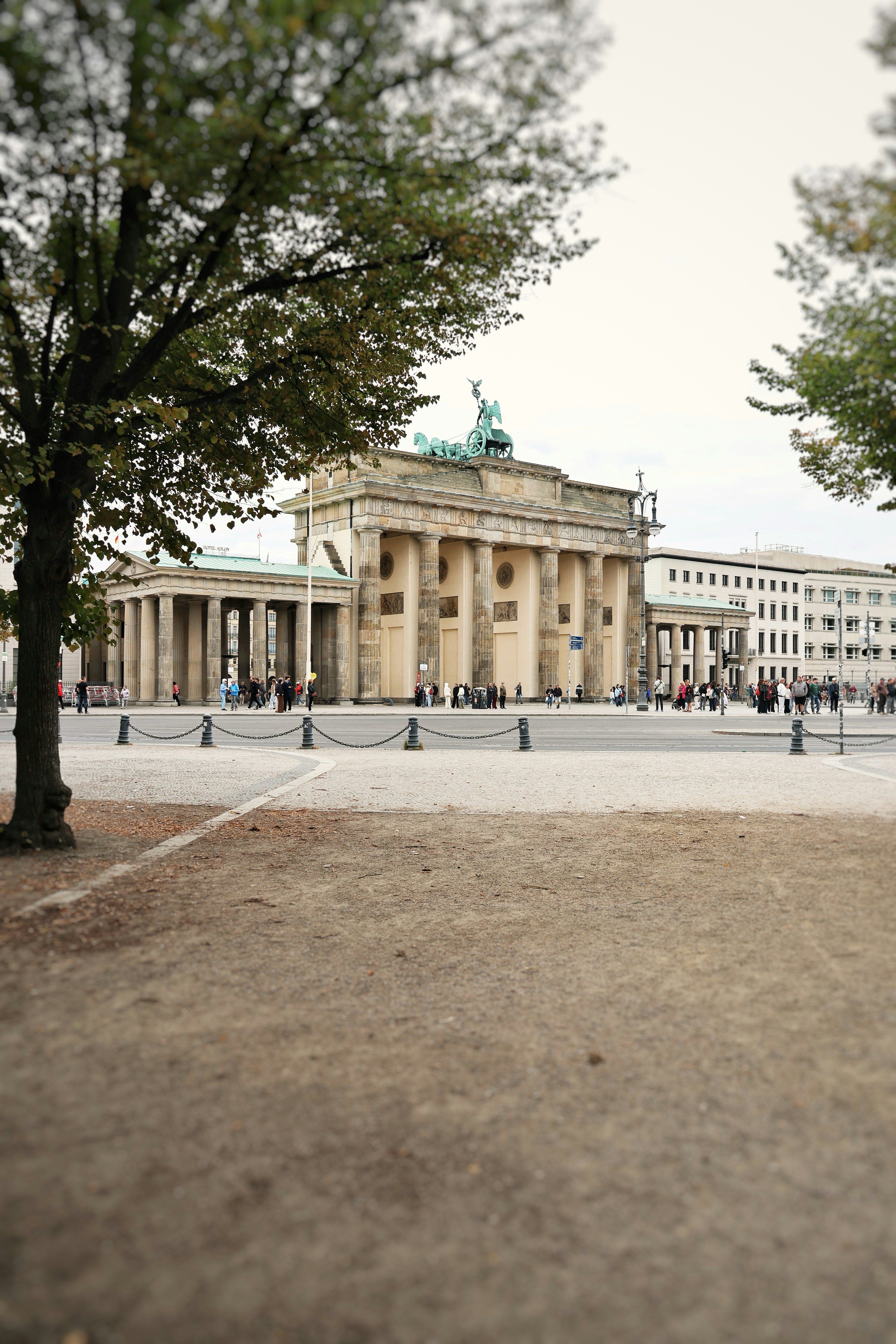 Brandenburg Gate through a courtyard of trees