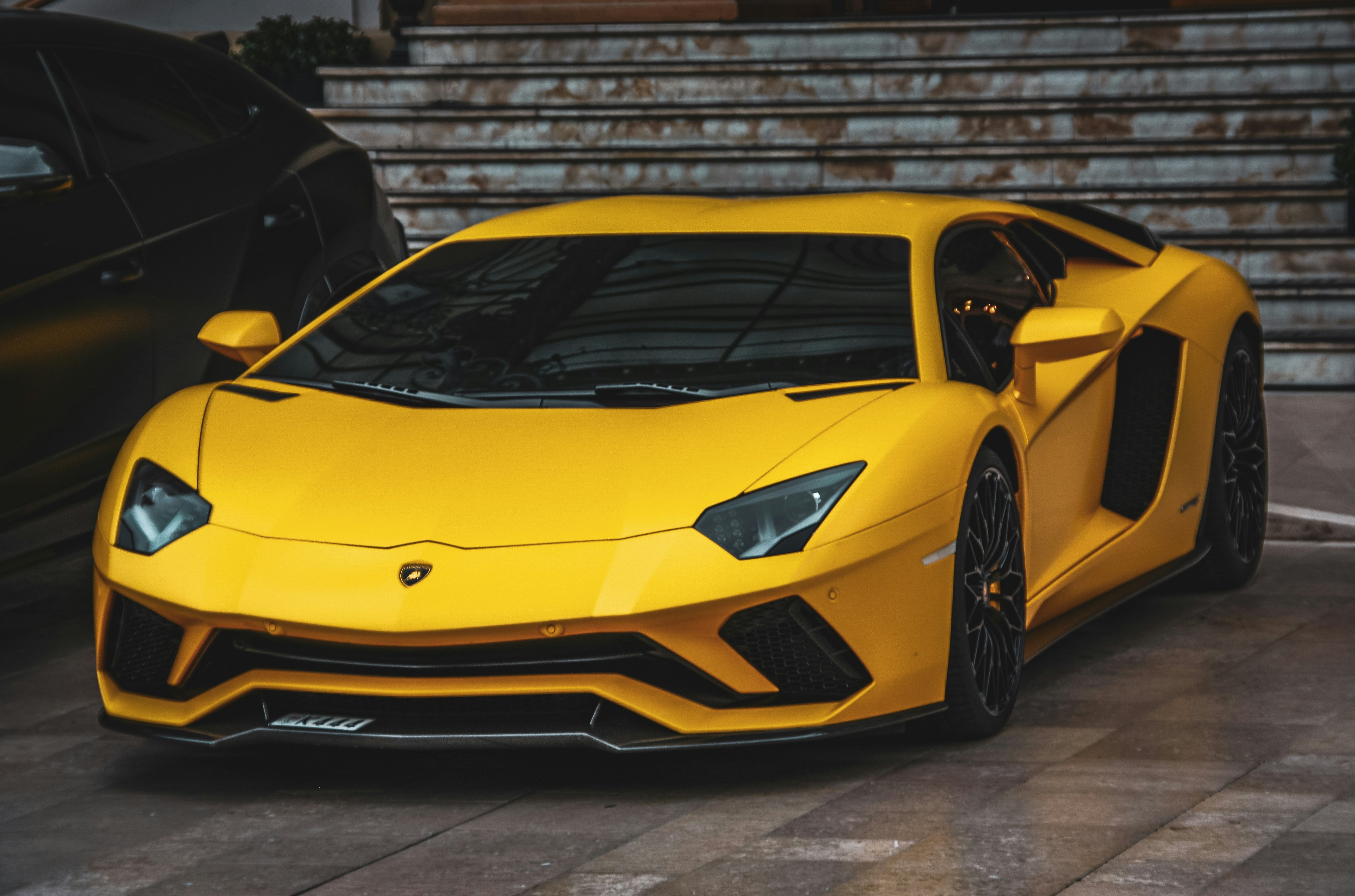 Luminous Bull: A Yellow Huracán Resting on Urban Steps