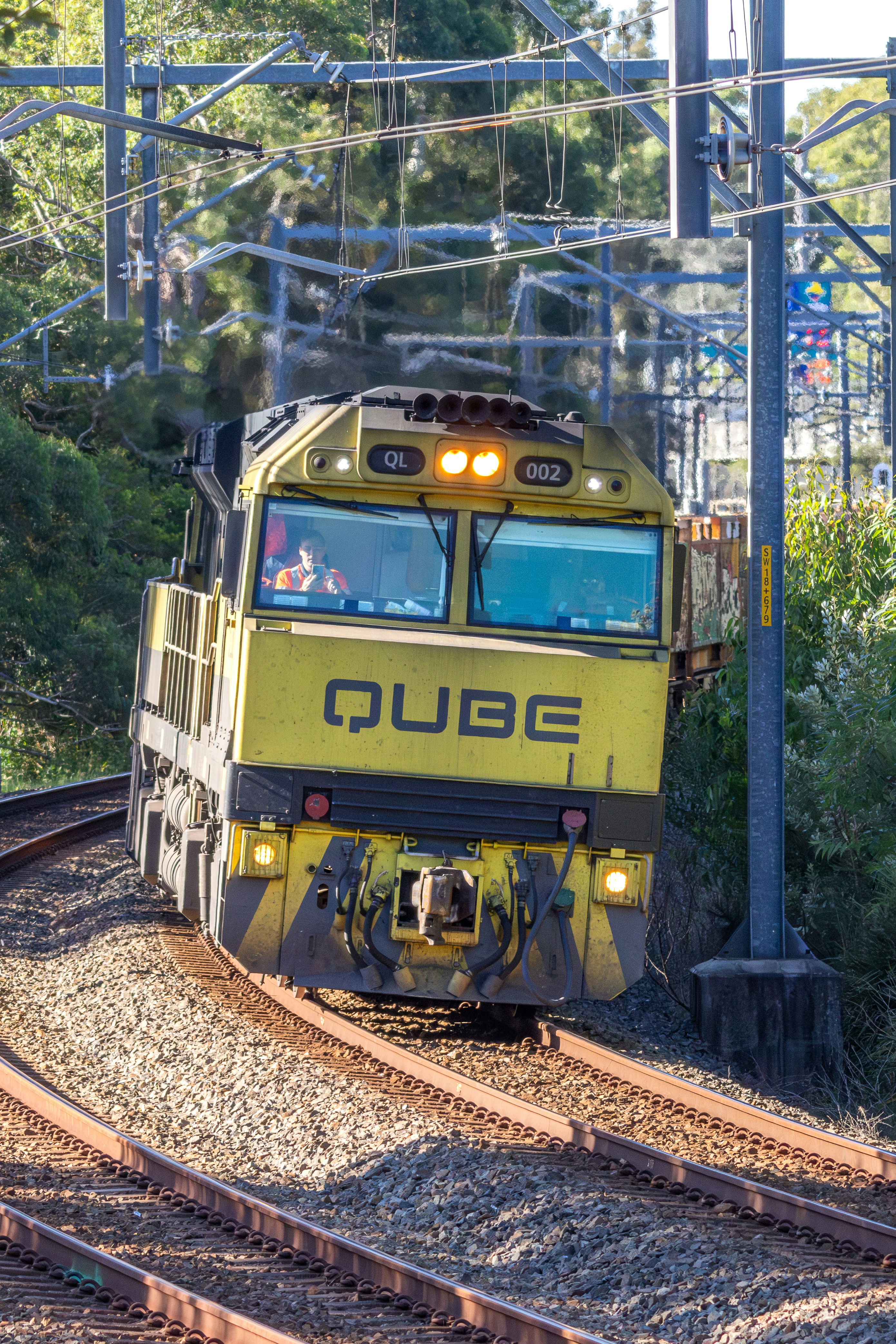 Yellow QUBE Locomotive Rounds the Bend