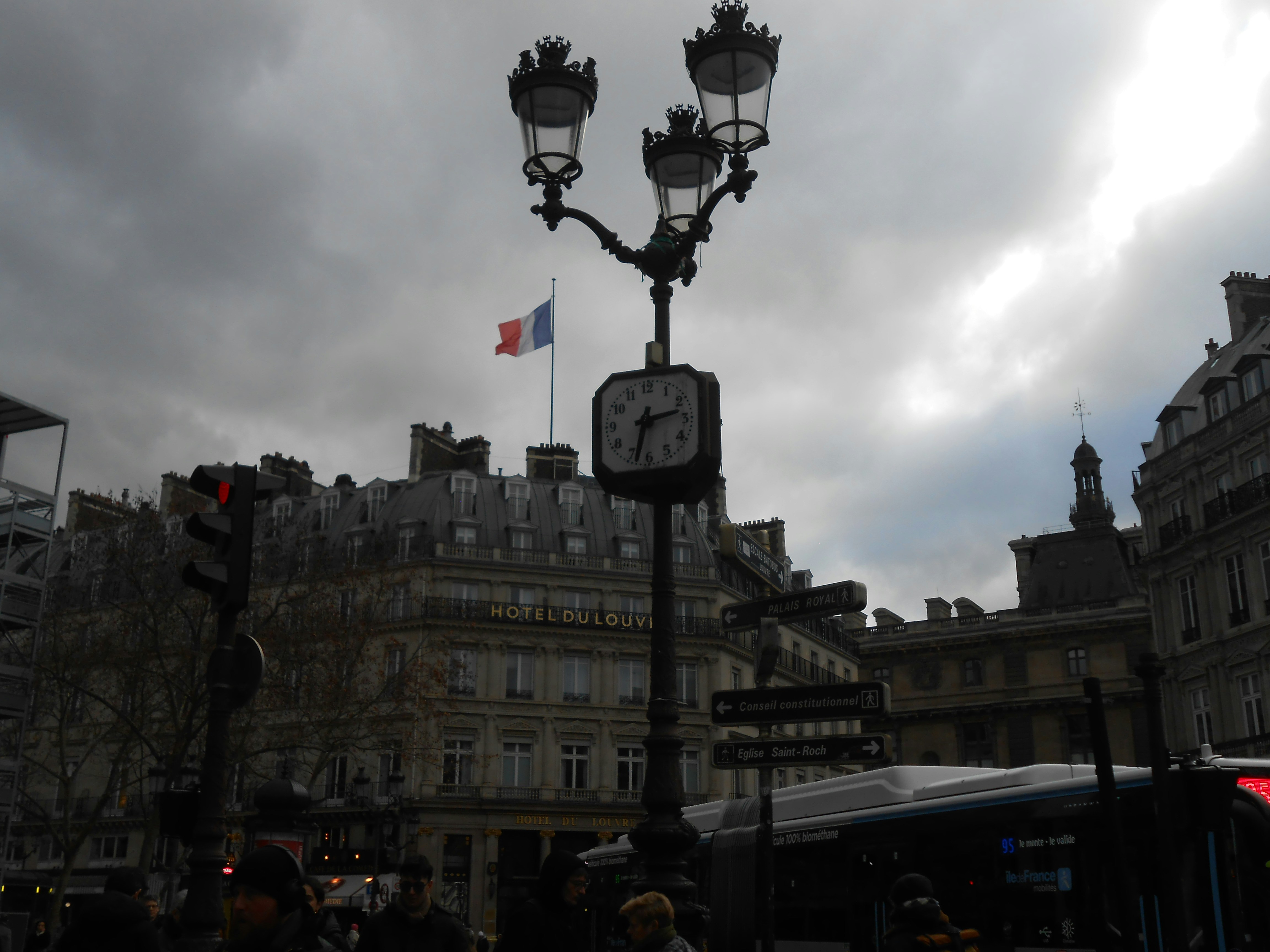 Clock, Flag, and Street: Parisian Intersection at Dusk