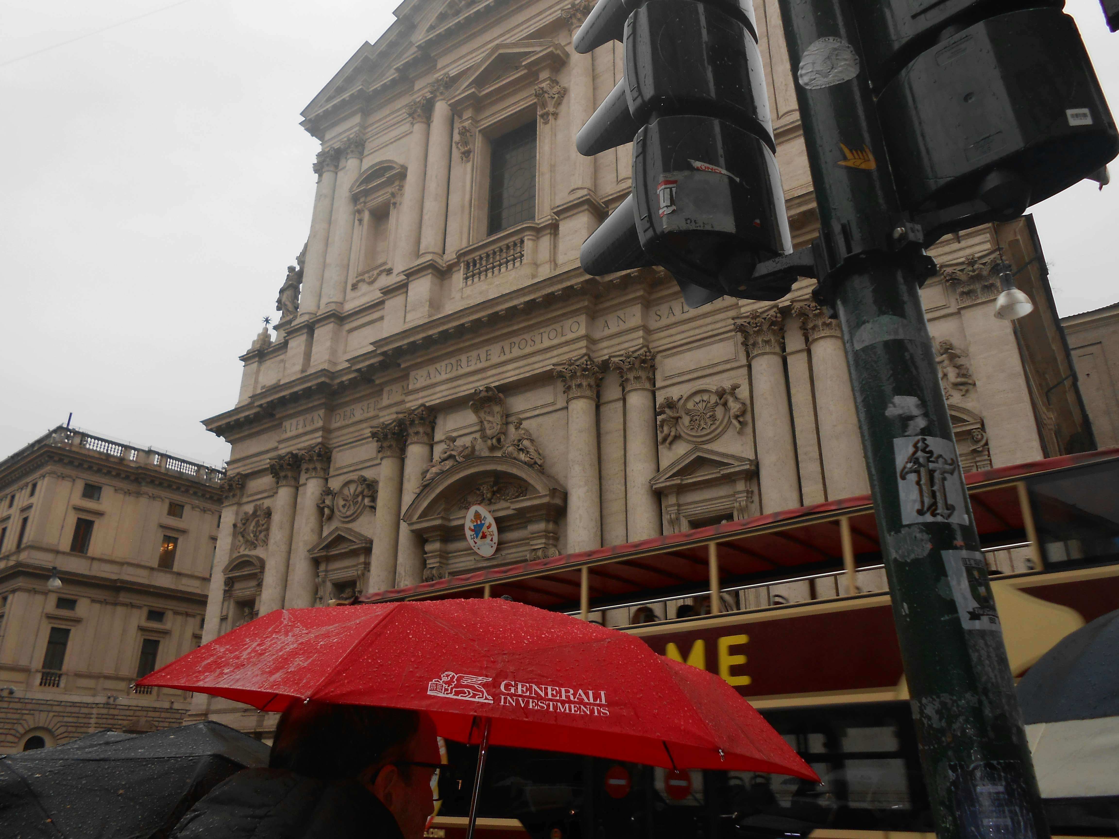 Red Umbrella Under Historic Facade