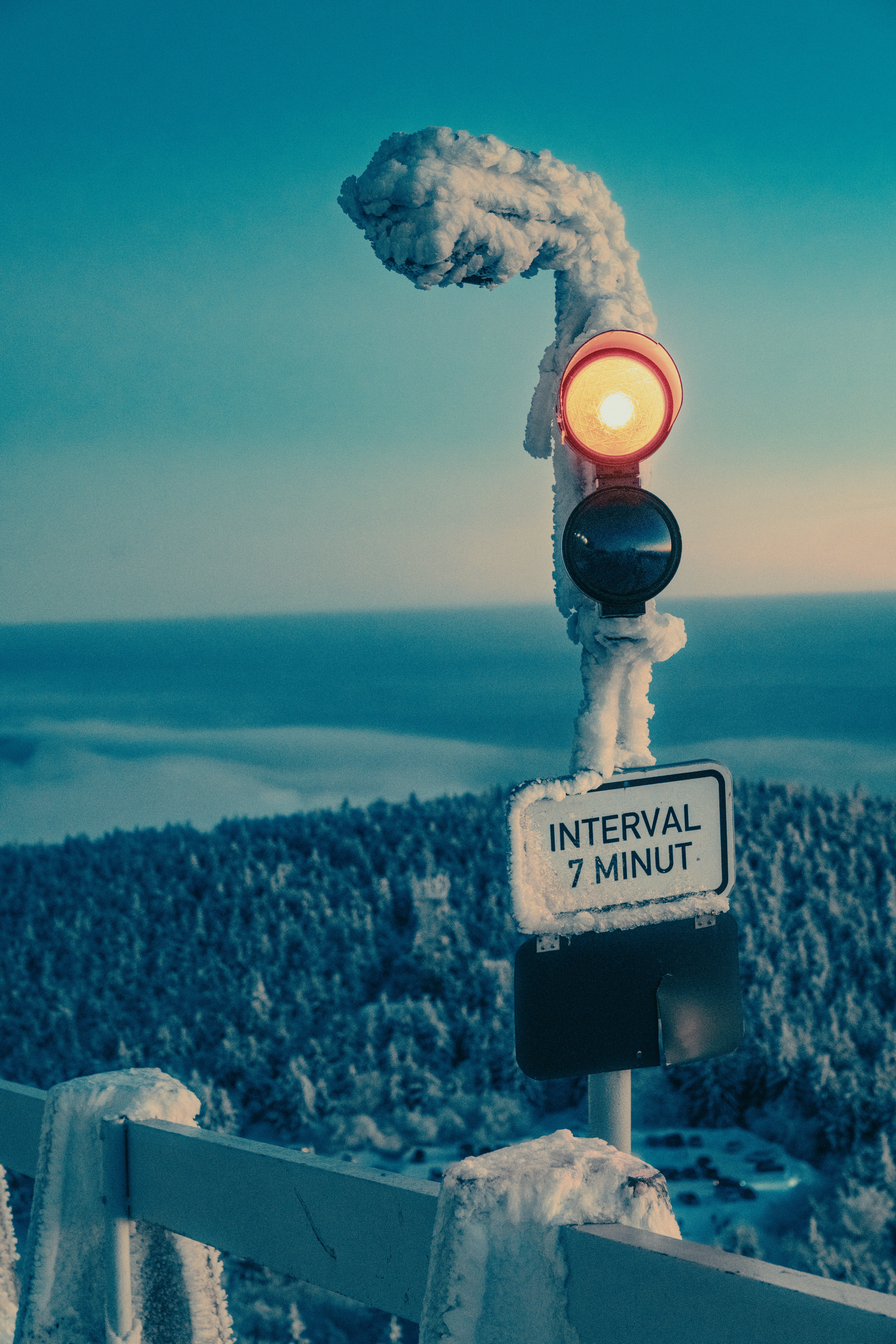 Frozen Signal: The Ice-Capped Rail Light Above the Snowbound Ridge
