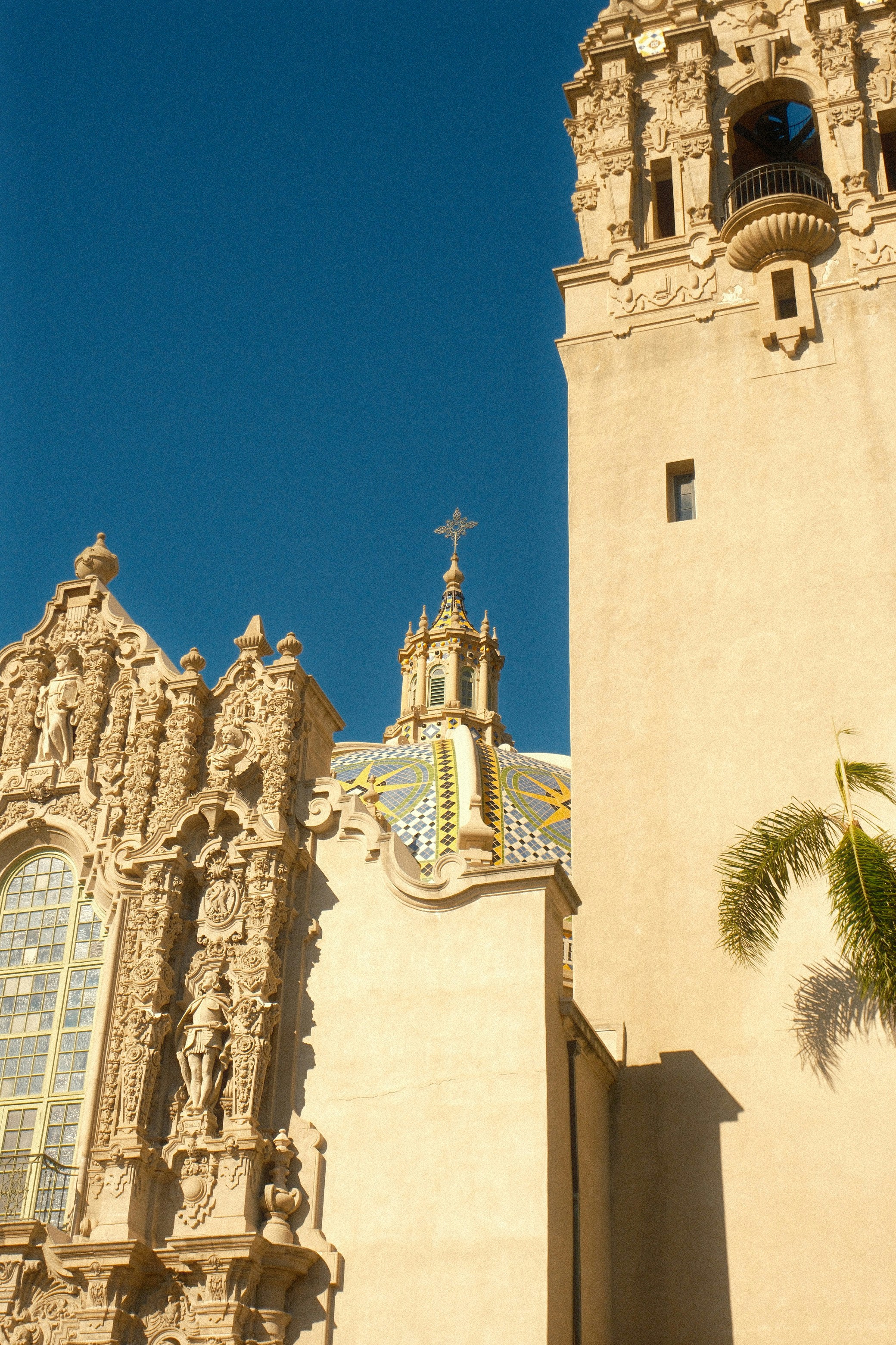 Sunlit Tower and Ornate Facade: A Spanish Colonial Cathedral under a Clear Sky
