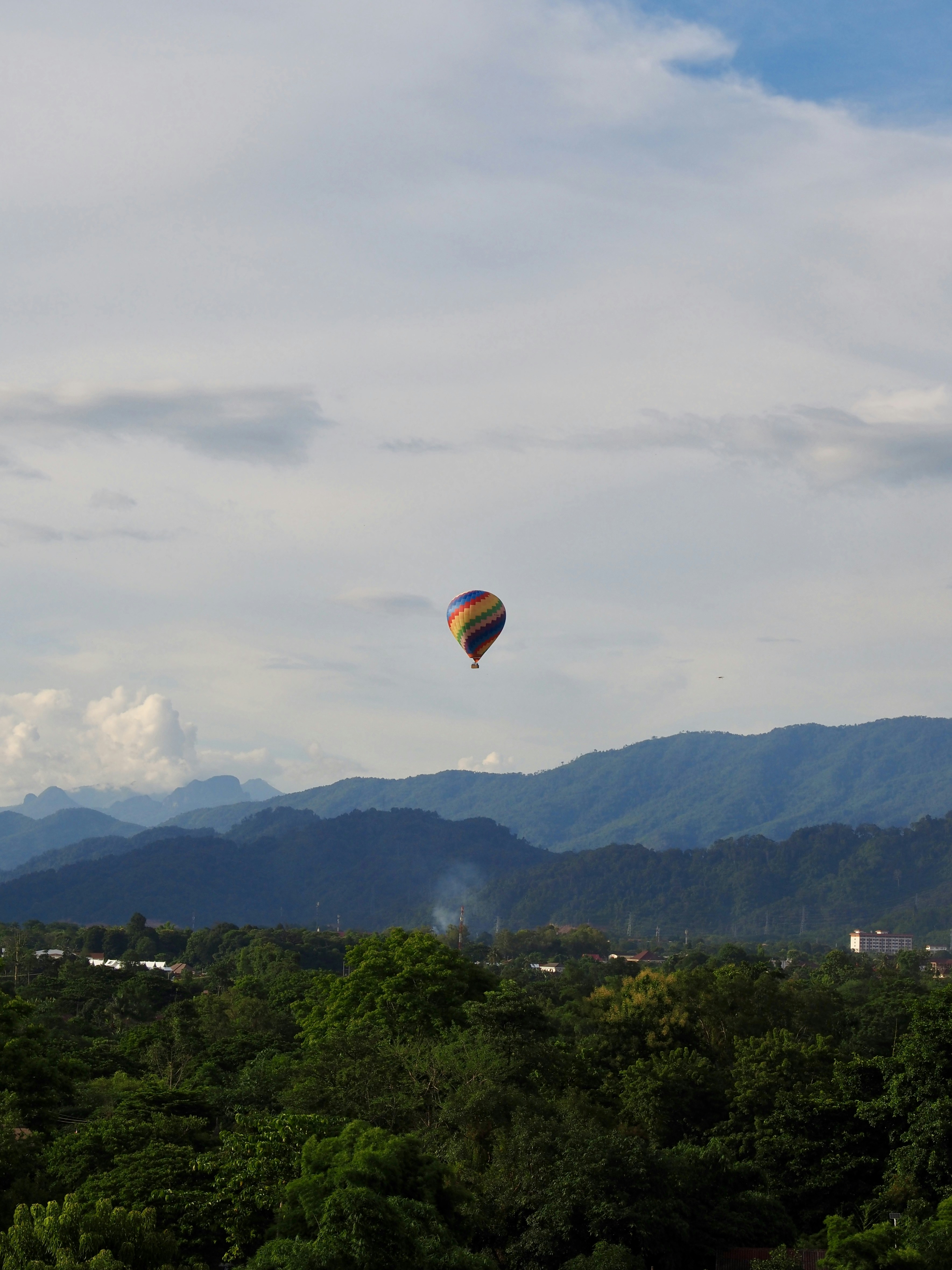 Rainbow Balloon Over a Quiet Valley