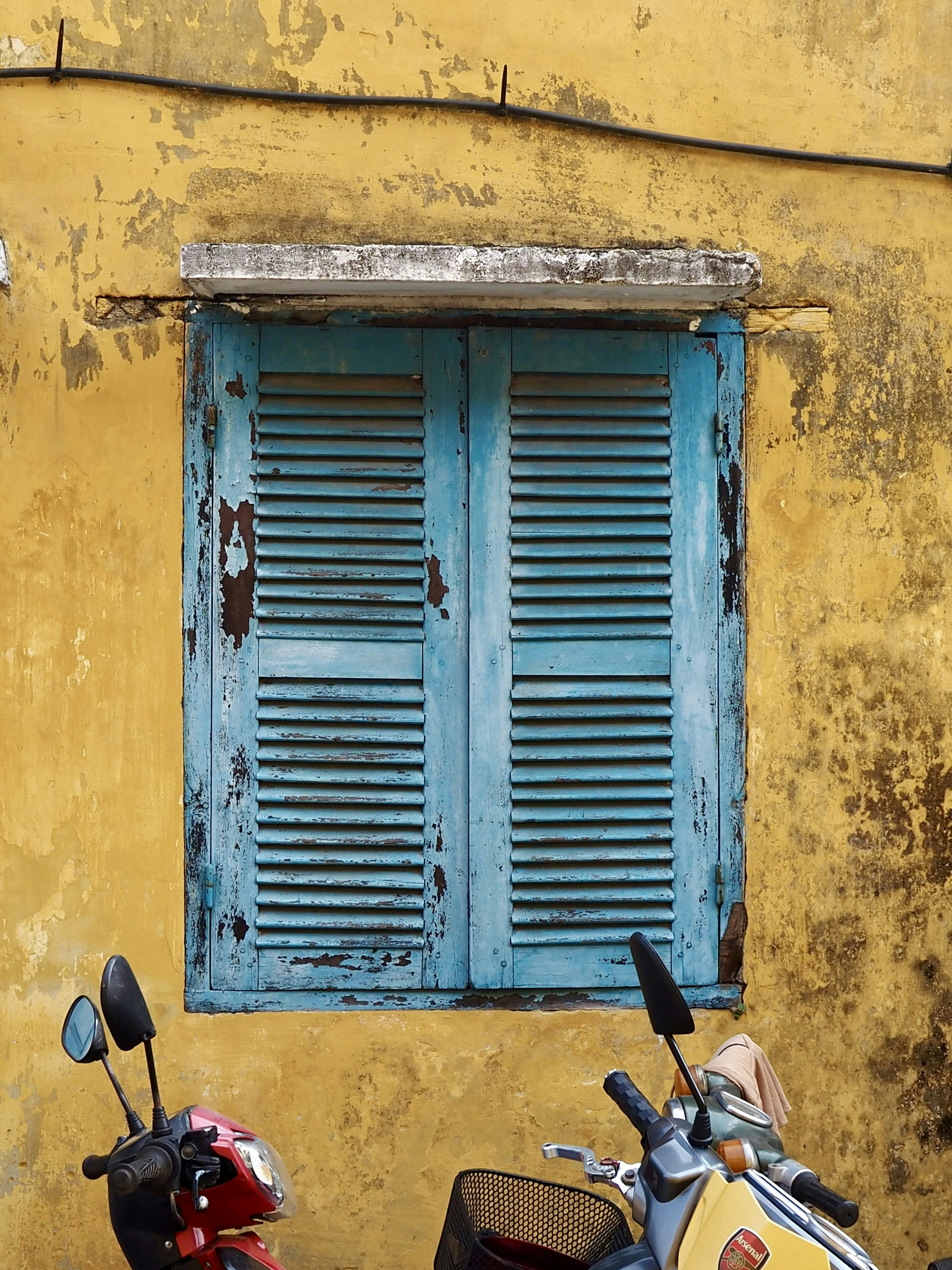 Chromatic Doorway in a Sunlit Yellow Facade