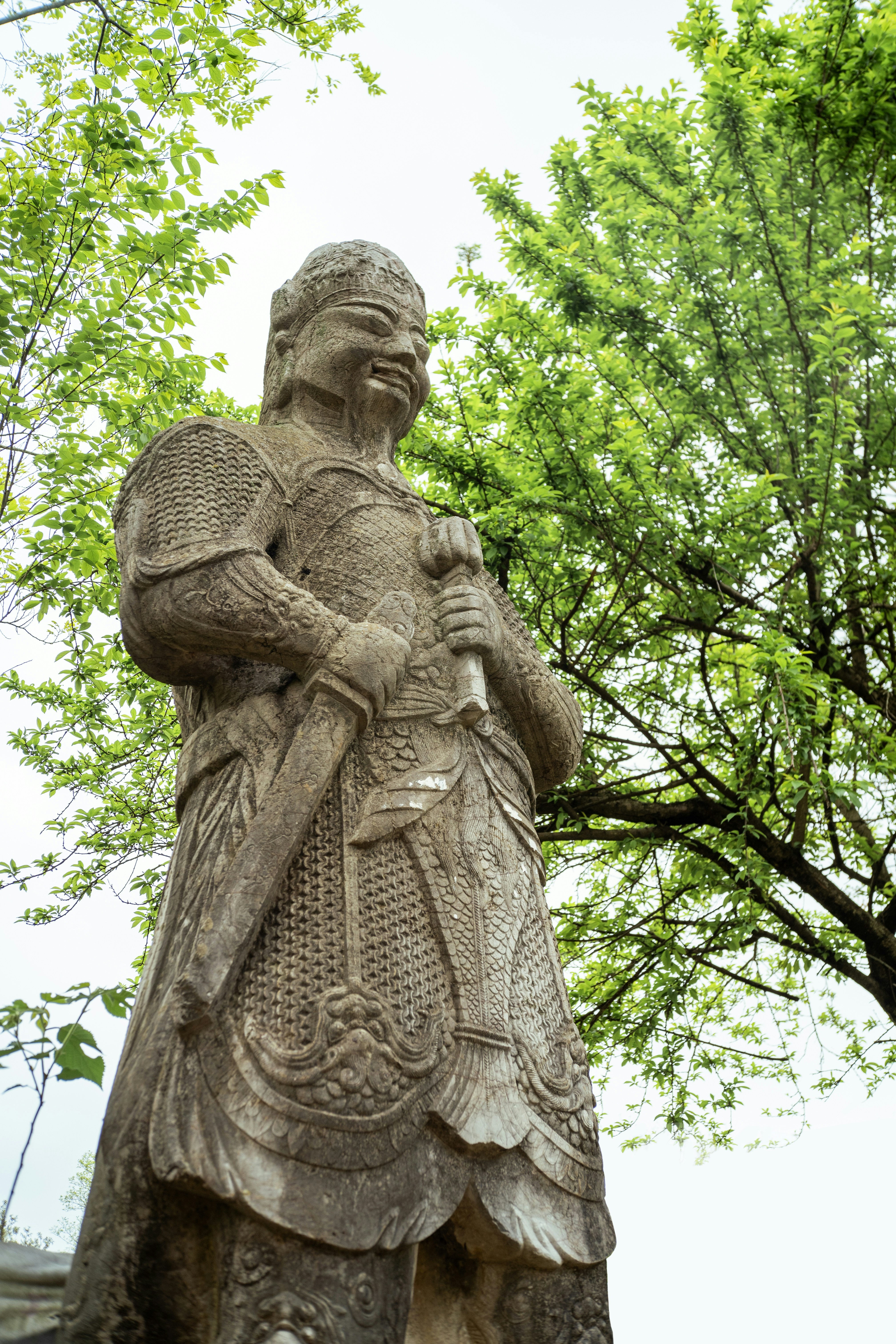 Stone Guardian Amid Green Canopy