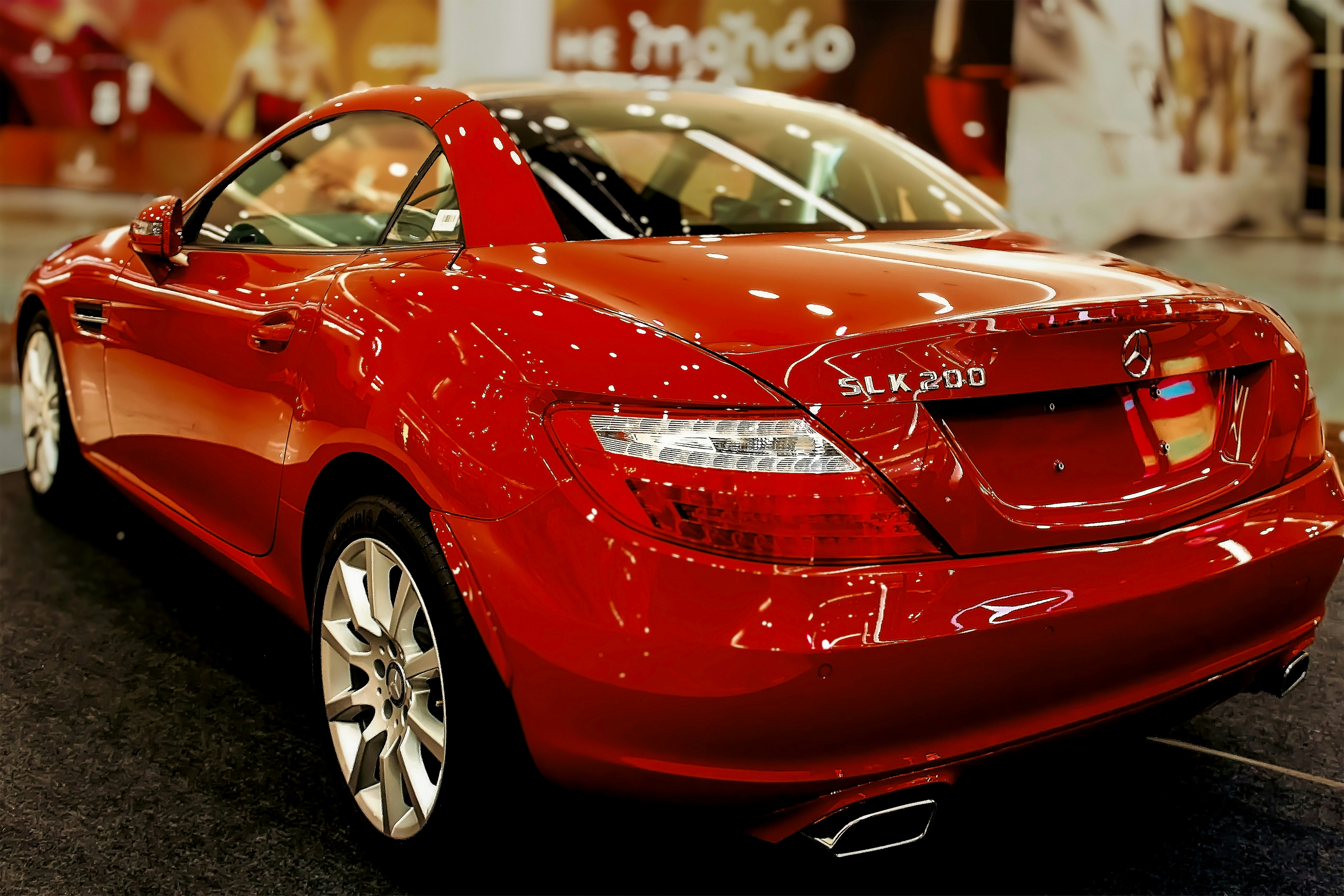 Red Mercedes SLK 200 at an Auto Show: Polished Curves and Glossy Reflections