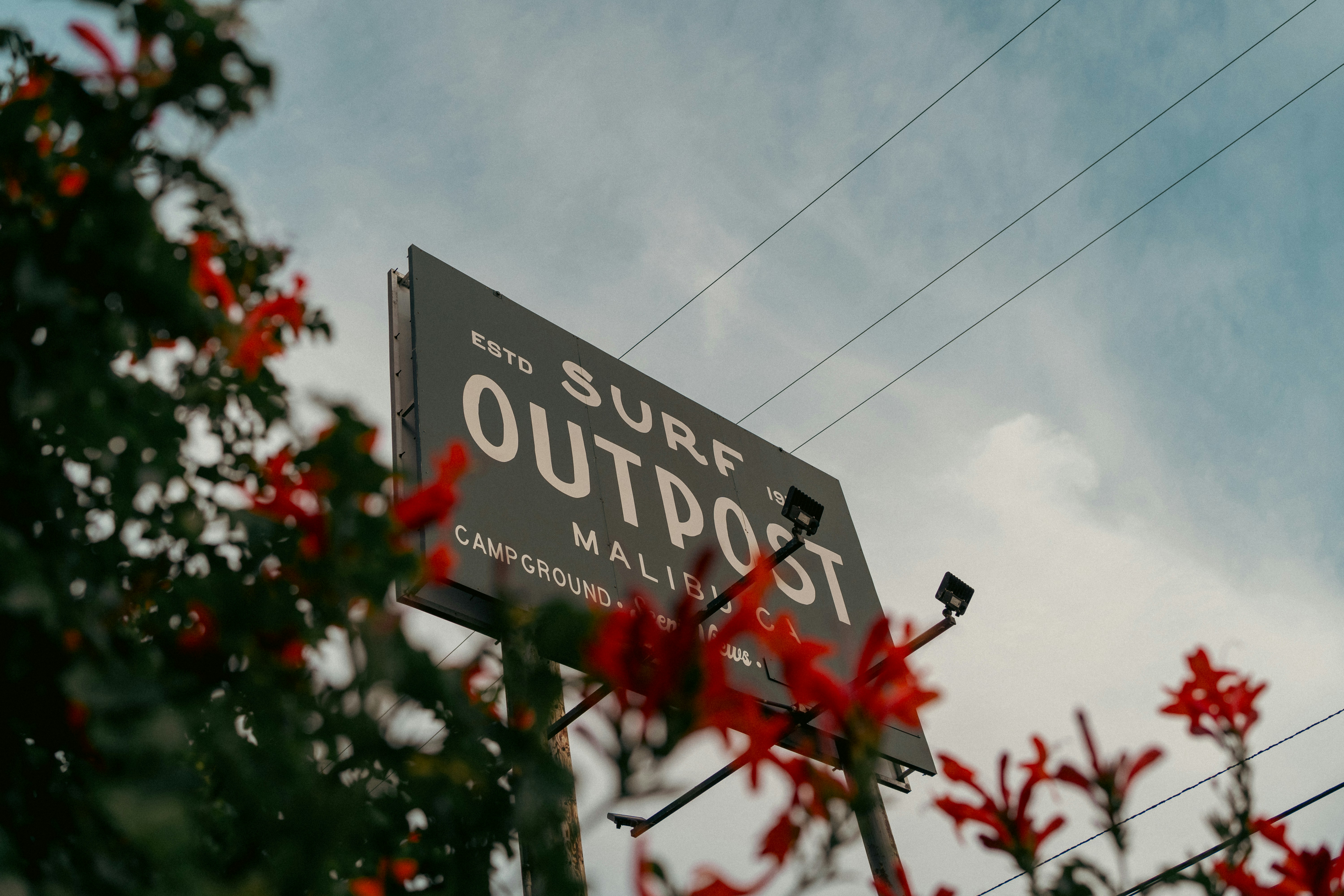 Surf Outpost Signover the Garden