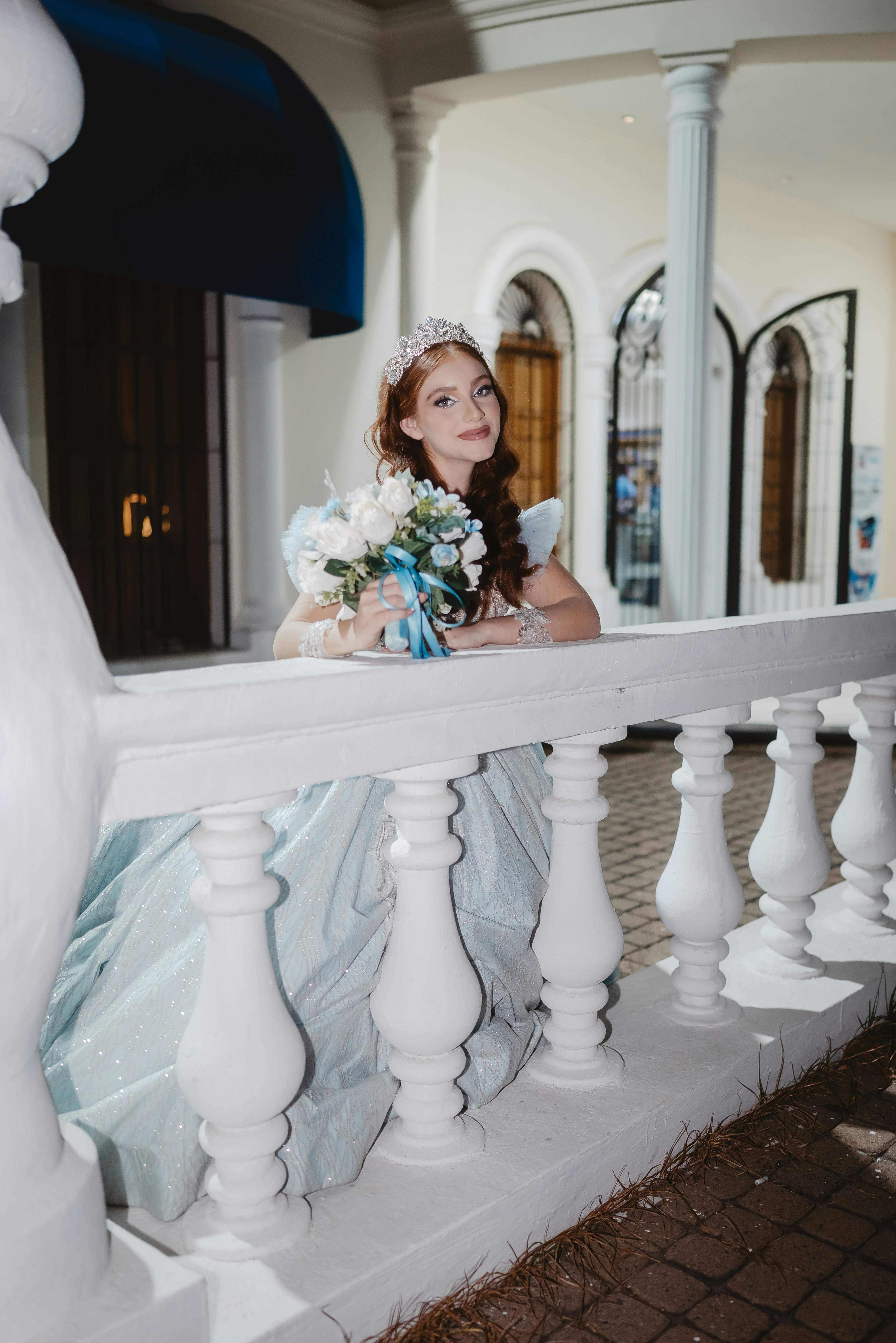 Princess in the colonnade: a quiet bouquet beneath the balustrade
