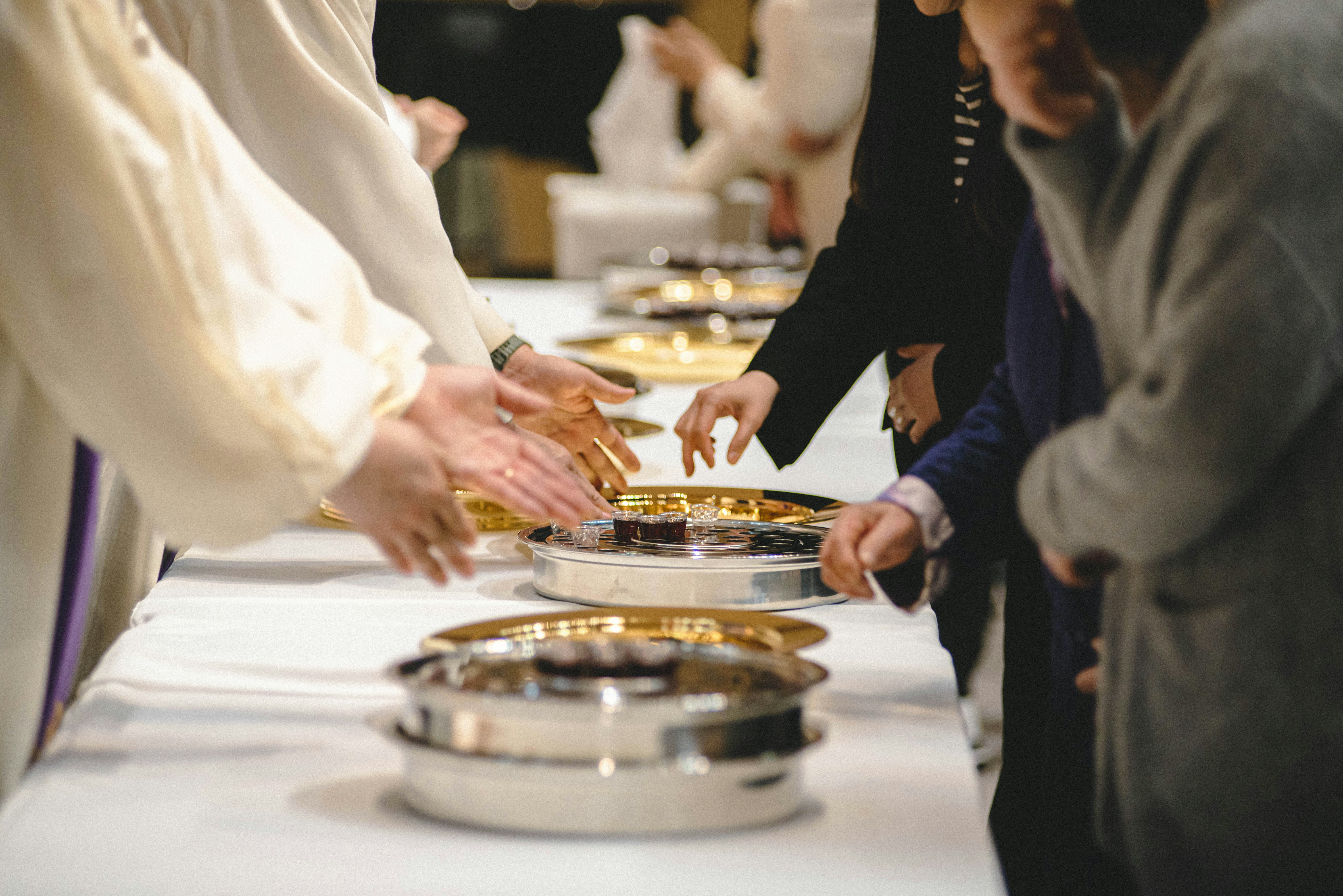 Hands in Focus: Guests Serving Delicacies at a Buffet Line