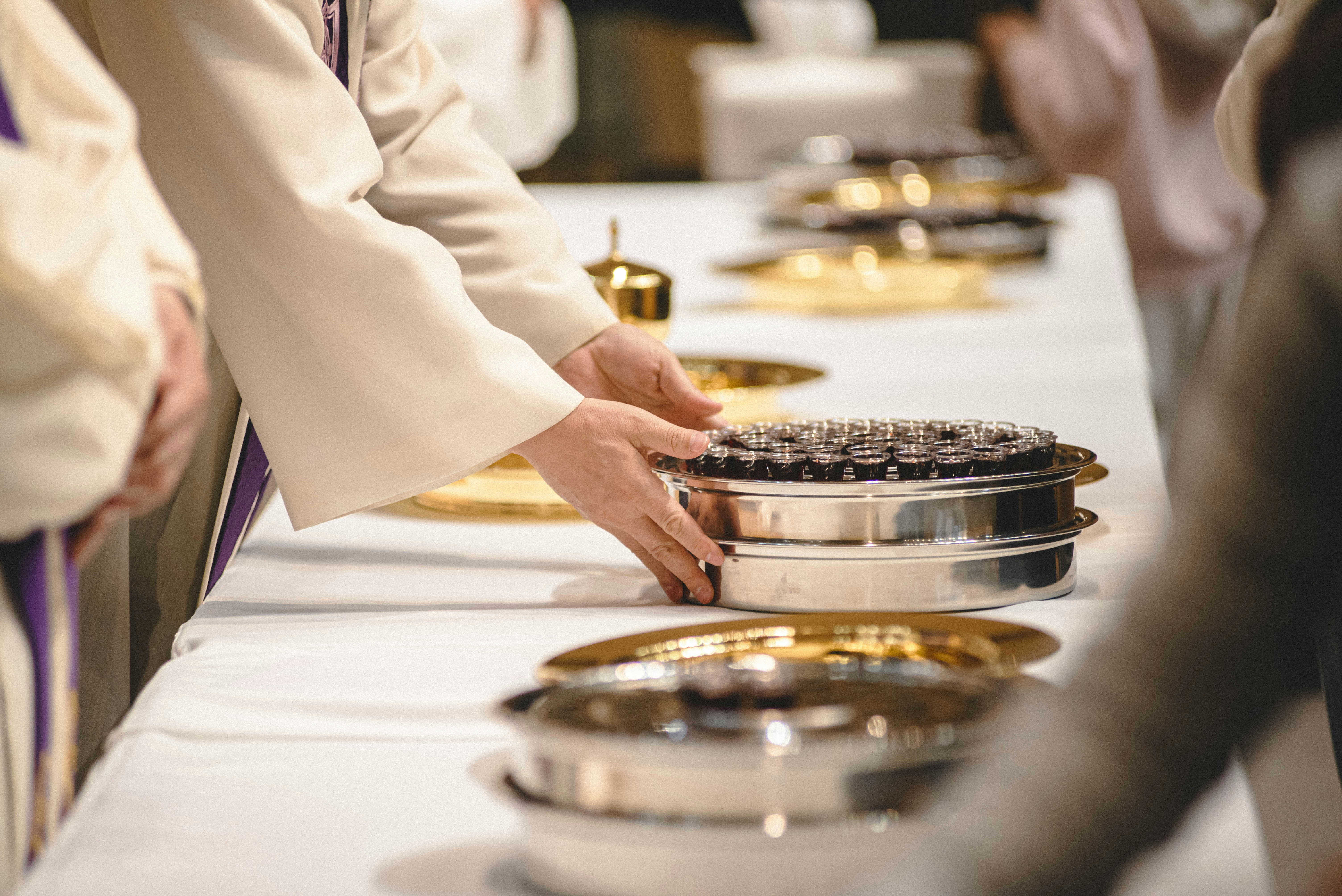 Chafing dishes and hands at a ceremonial buffet