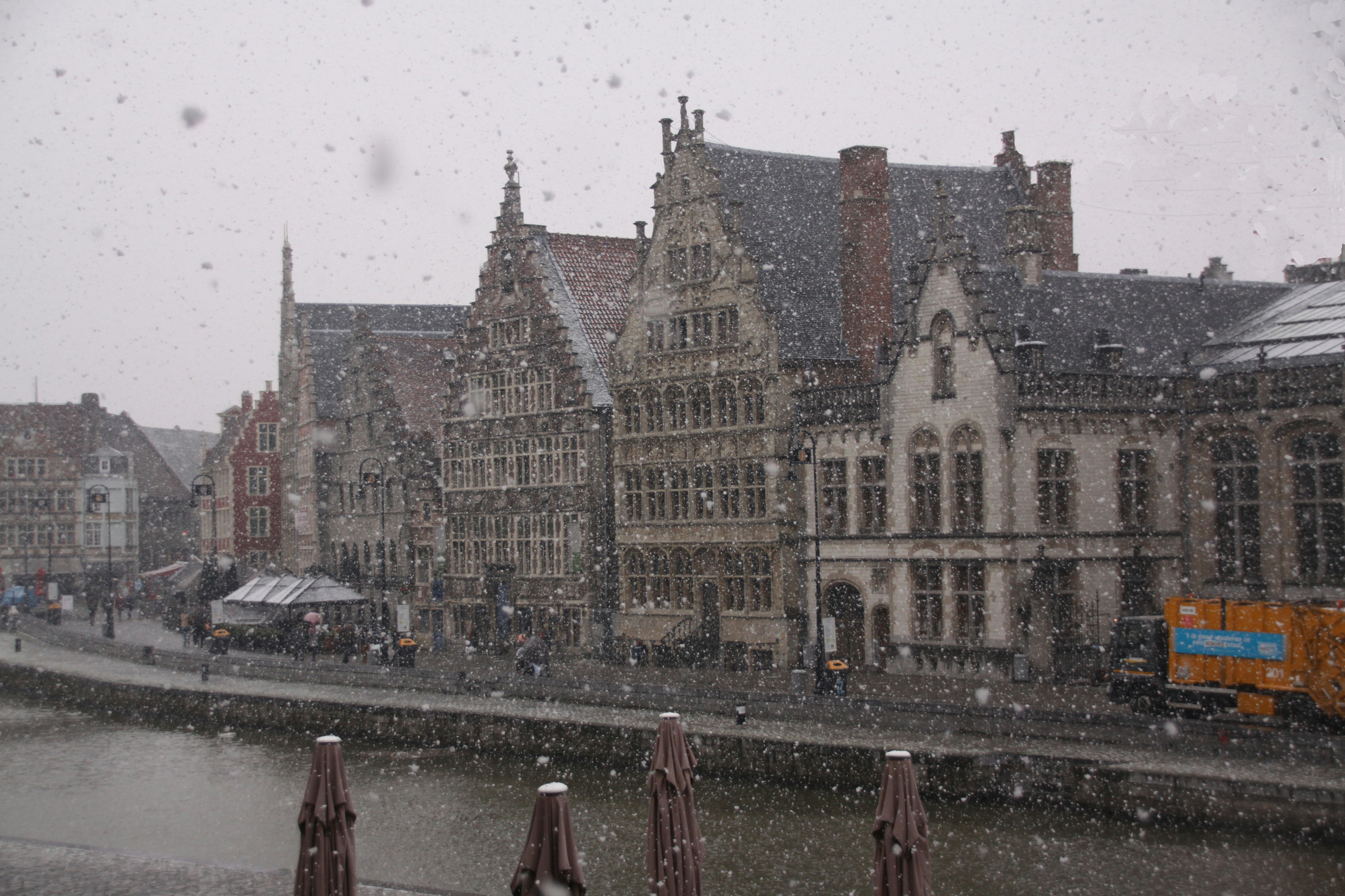 Snowy Flemish Row Houses Along a Canal