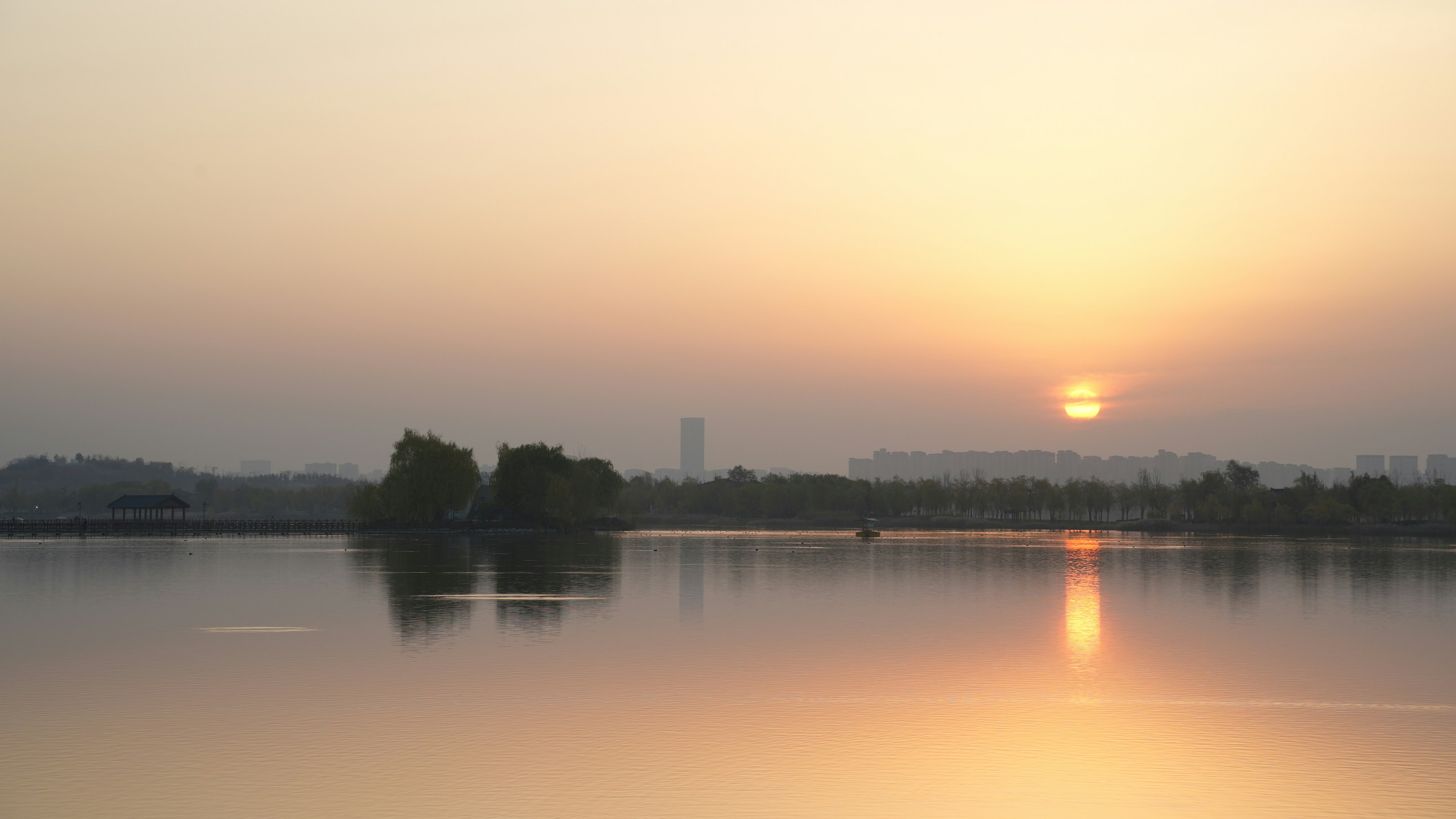 Sunset on a Quiet Canal: Golden Light Reflects Across Still Waters