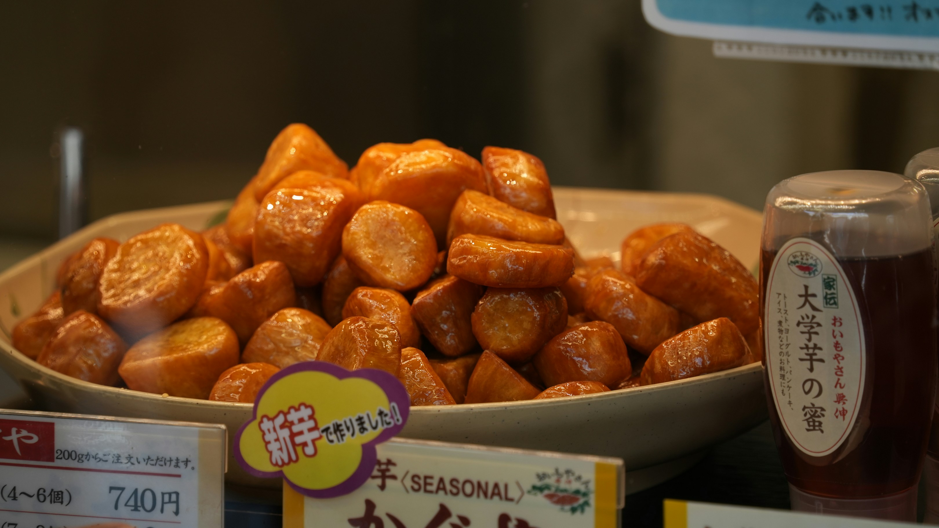 Cascading Plate of Golden Bites: Glazed Sausages under Soft Market Light
