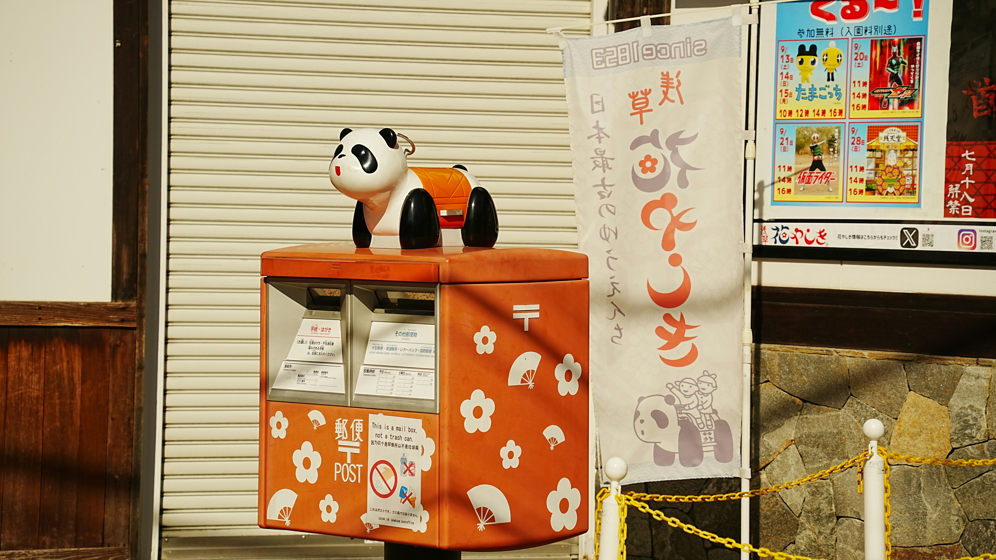 Panda Post: A Tiny Orange Mailbox Graced by a Plush Visitor