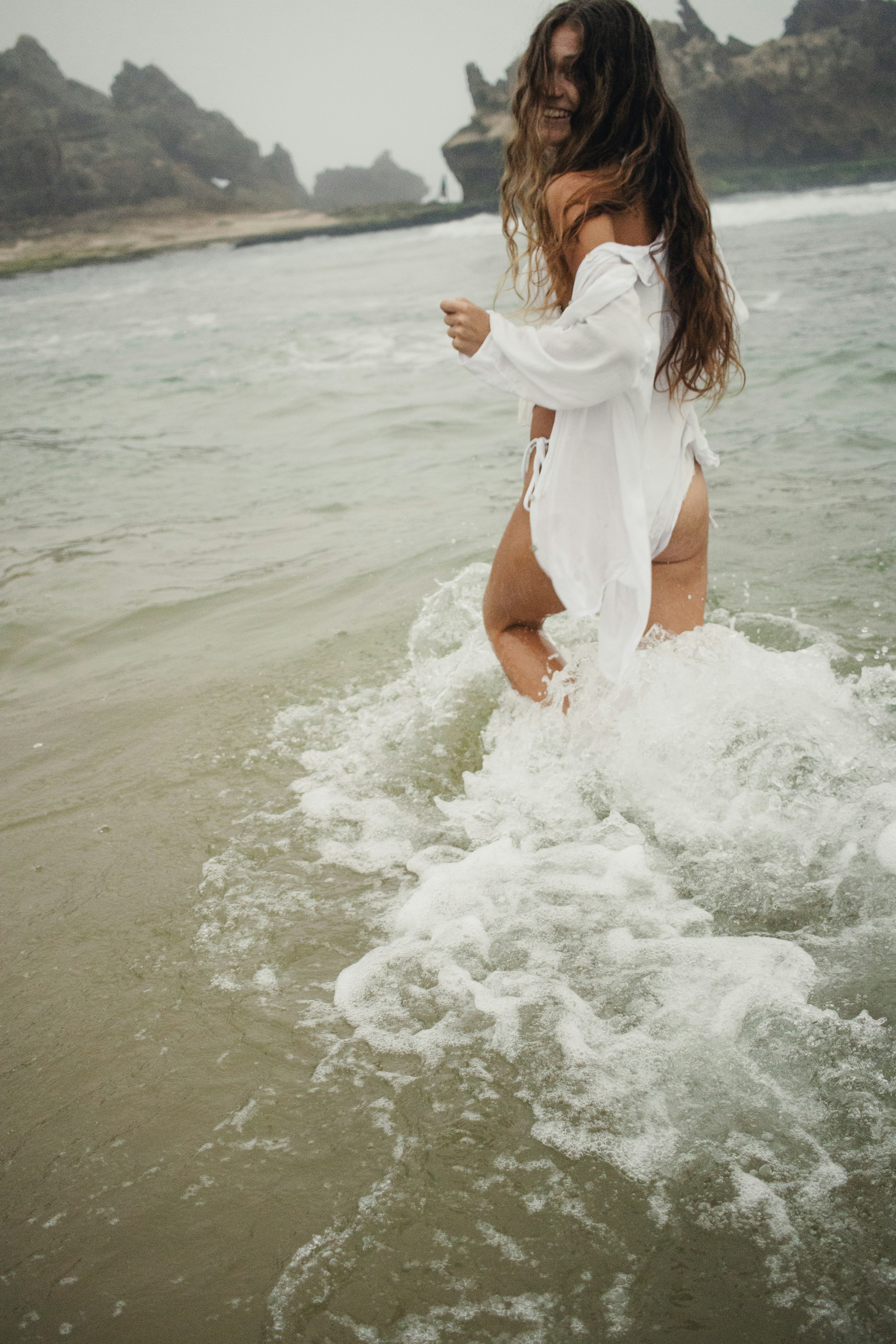White-robe Wanderer at the Surf—A Beach Portrait
