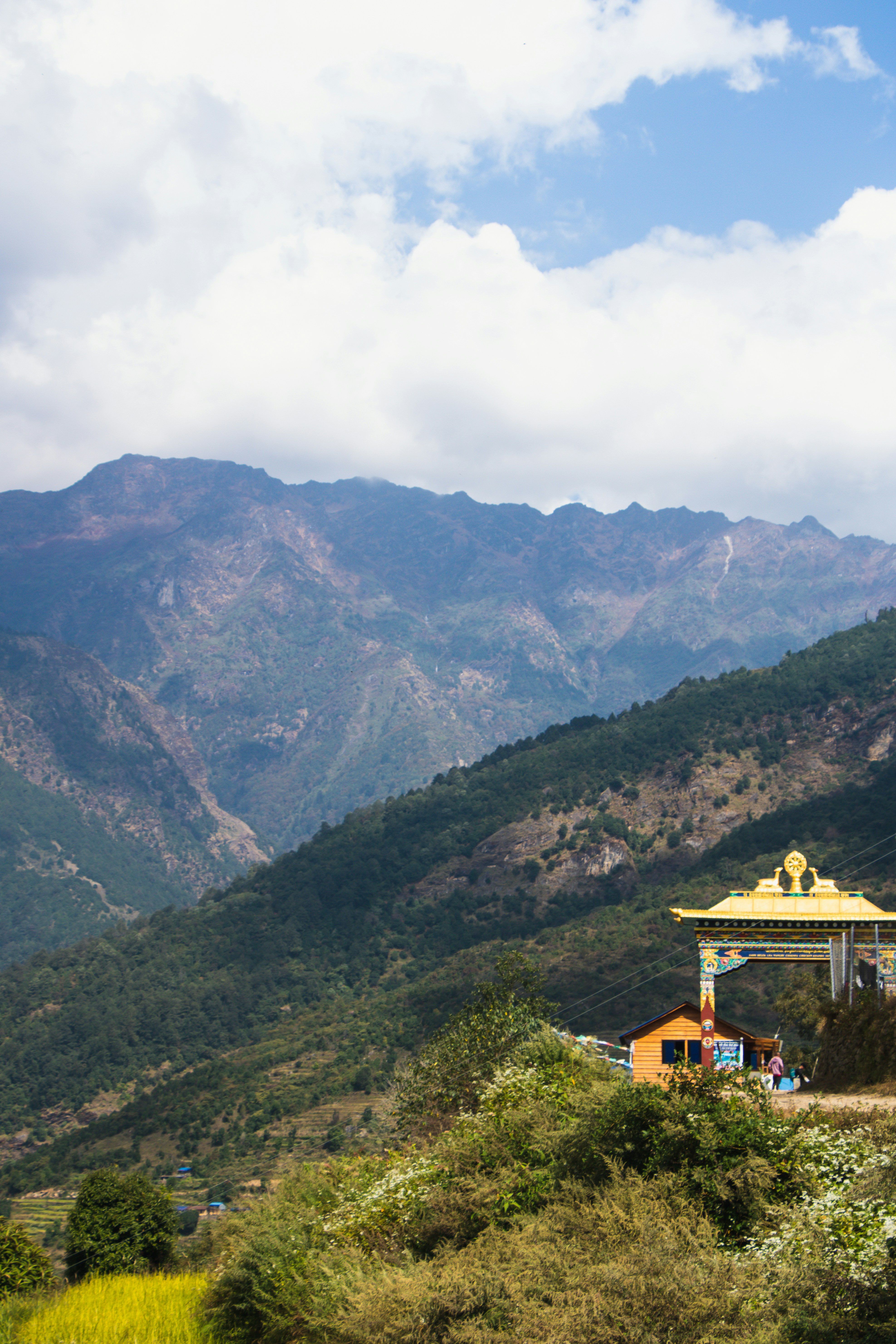 Sunlit Temple Gate Anchored by Mountain Gleam