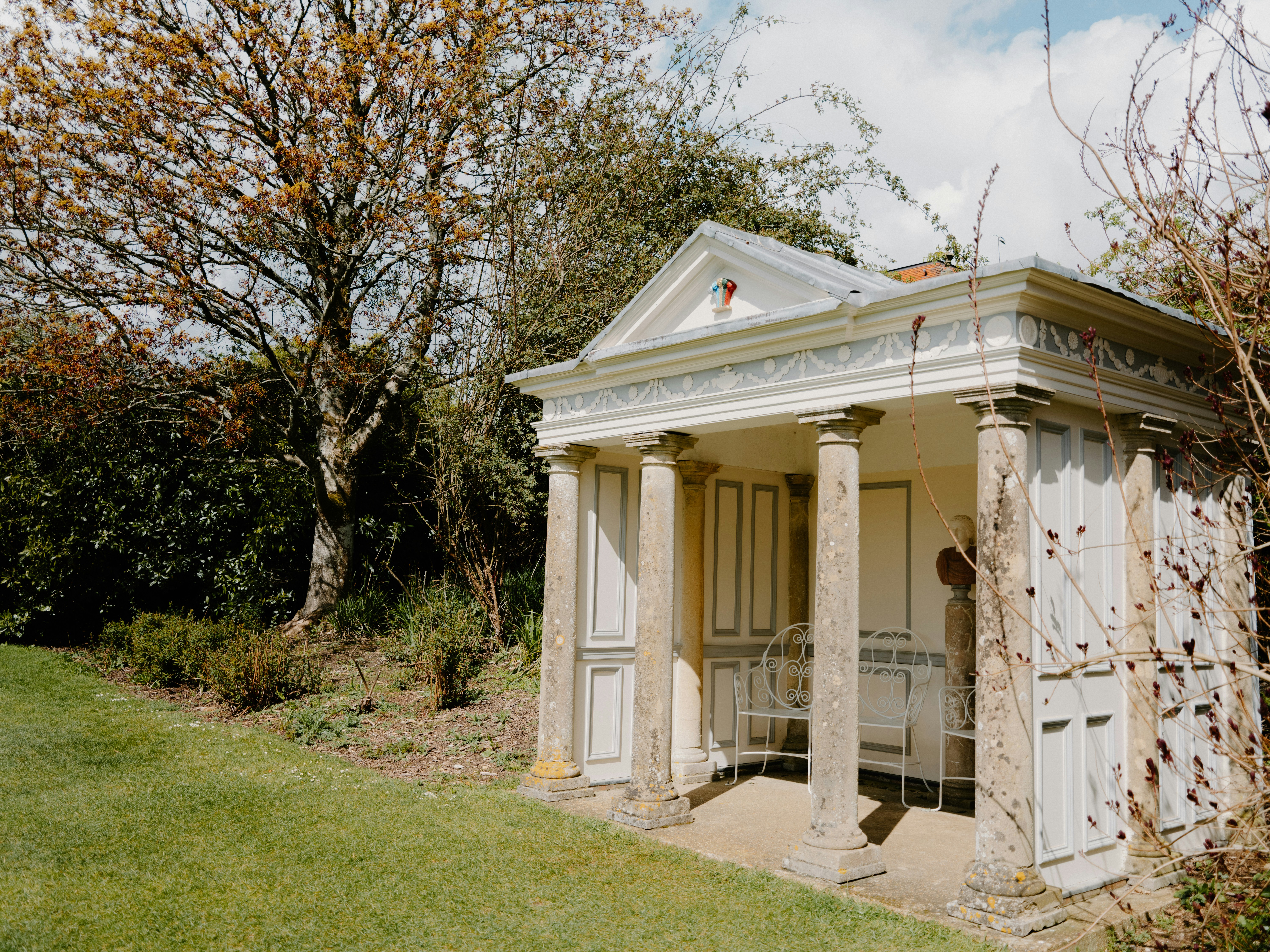 Sunlit Columned Nook: A Quiet Garden Porch