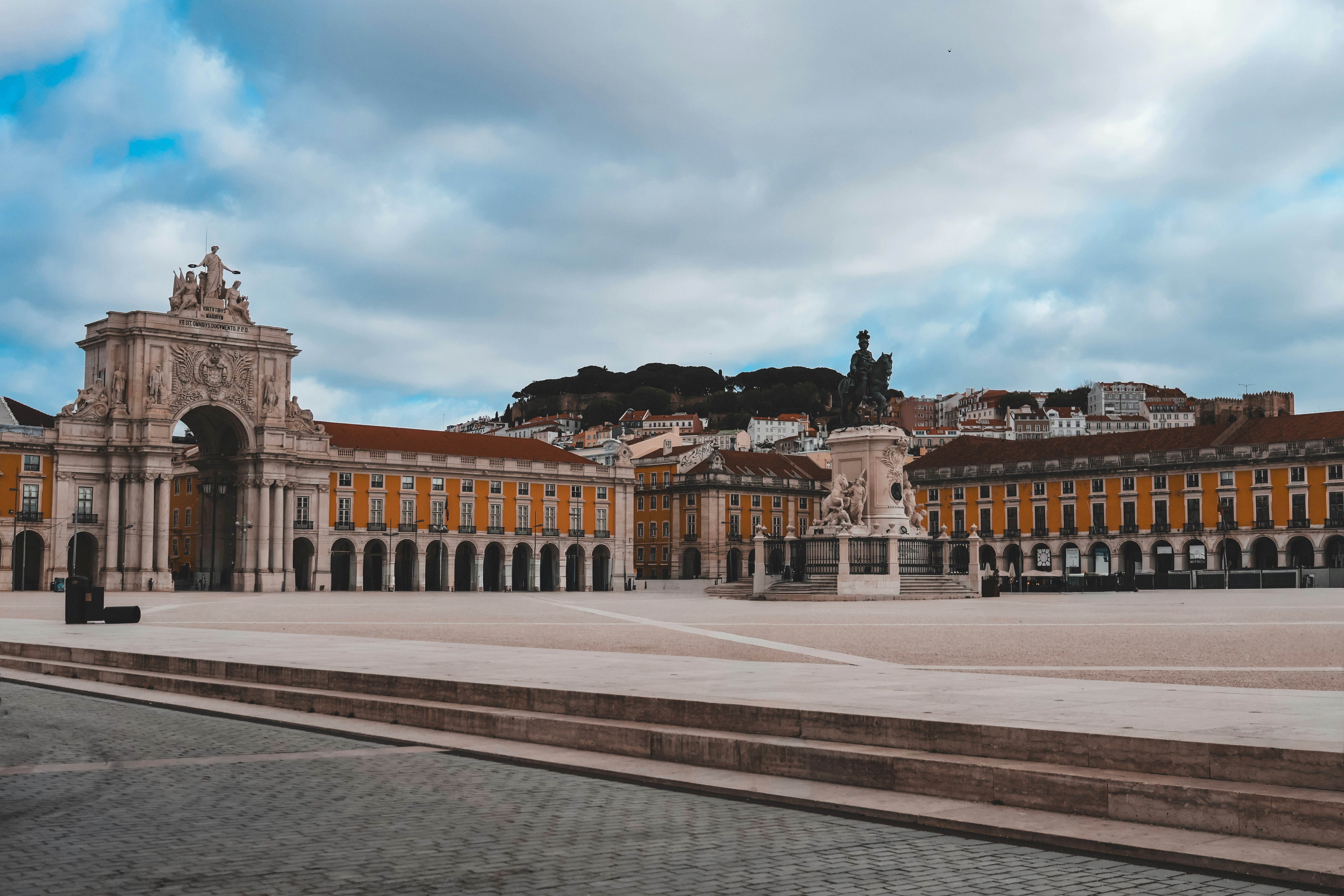 Neoclassical Arch and Monument Overlooking a Sunlit Plaza