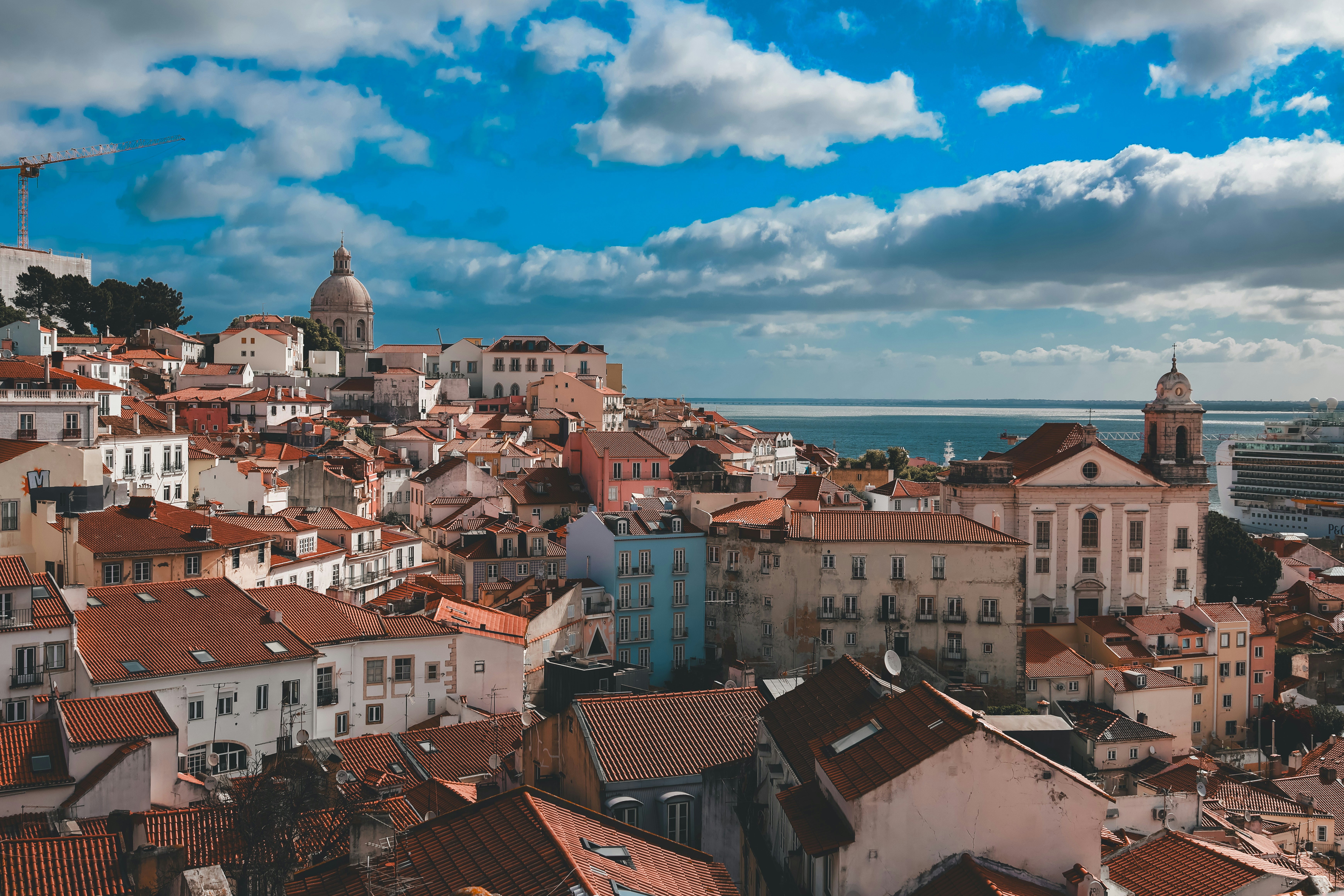 Salt-tinged panorama of a sunlit coastal town with terracotta rooftops