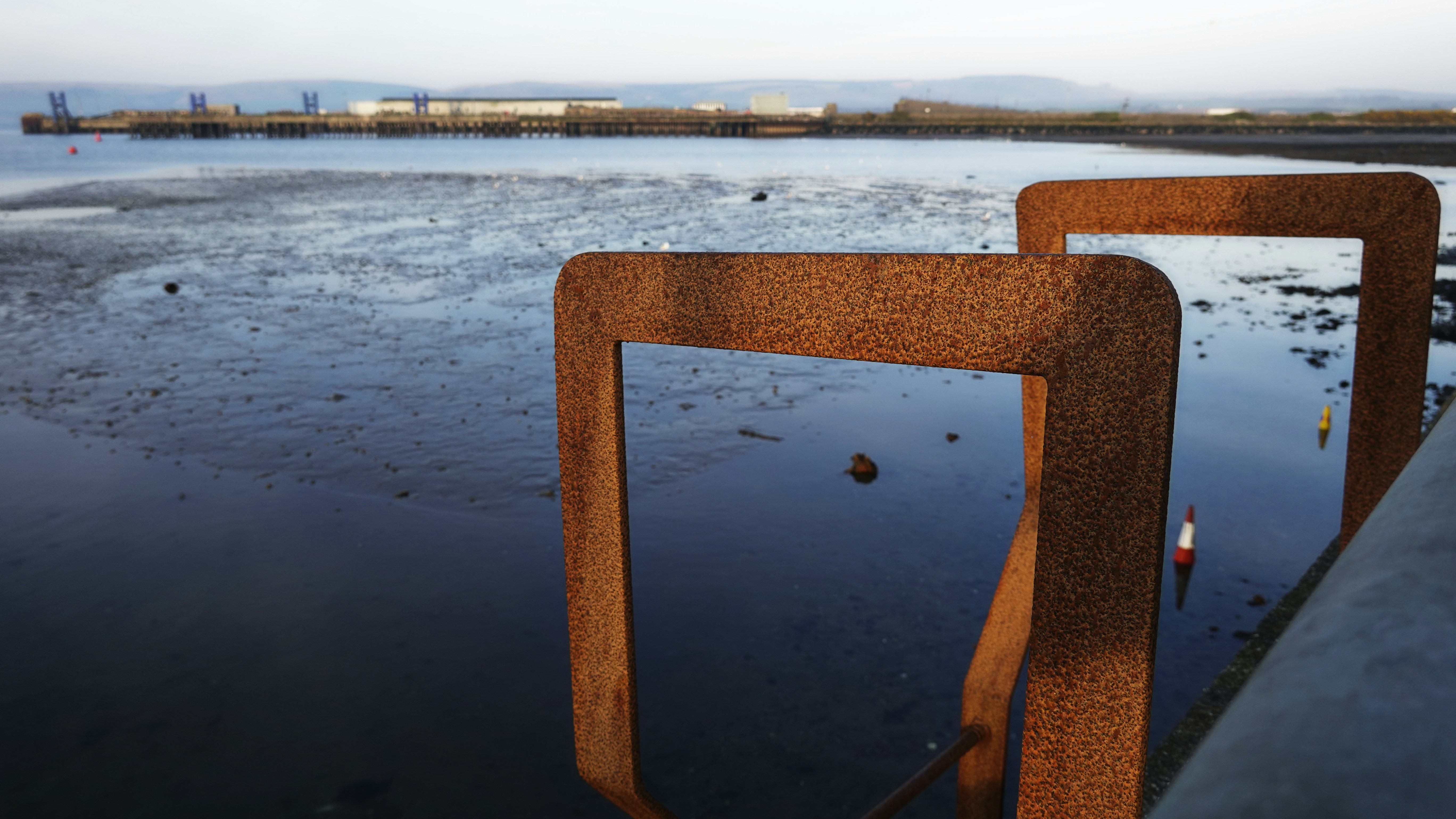 Rusted frames over a tidal plain