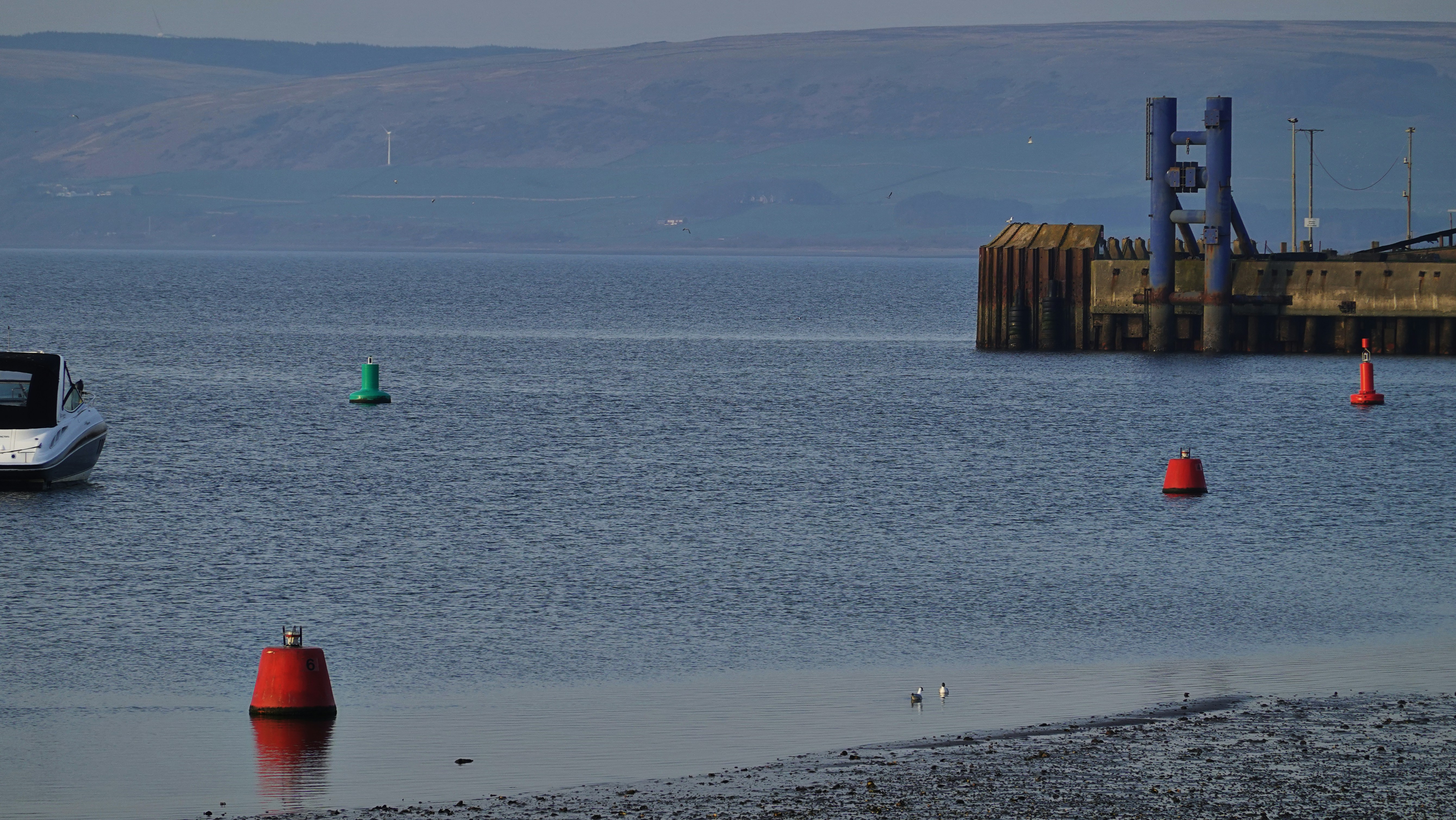 Buoyant Harbor Echoes: A Quiet Convergence of Water, Buoys, and Distant Breakwater
