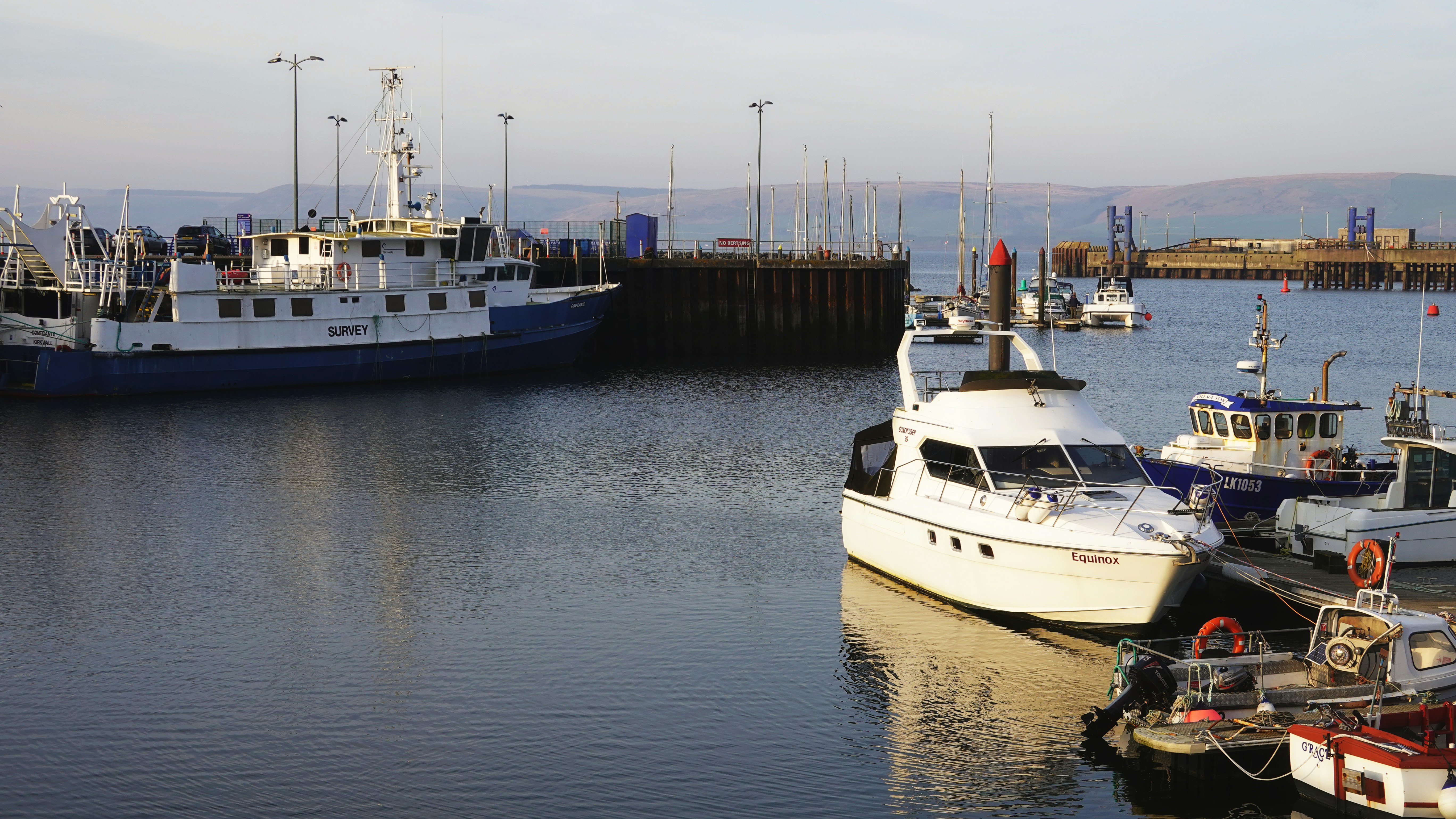 Harbor Quiet: White Boats Rest at Sunny Quay