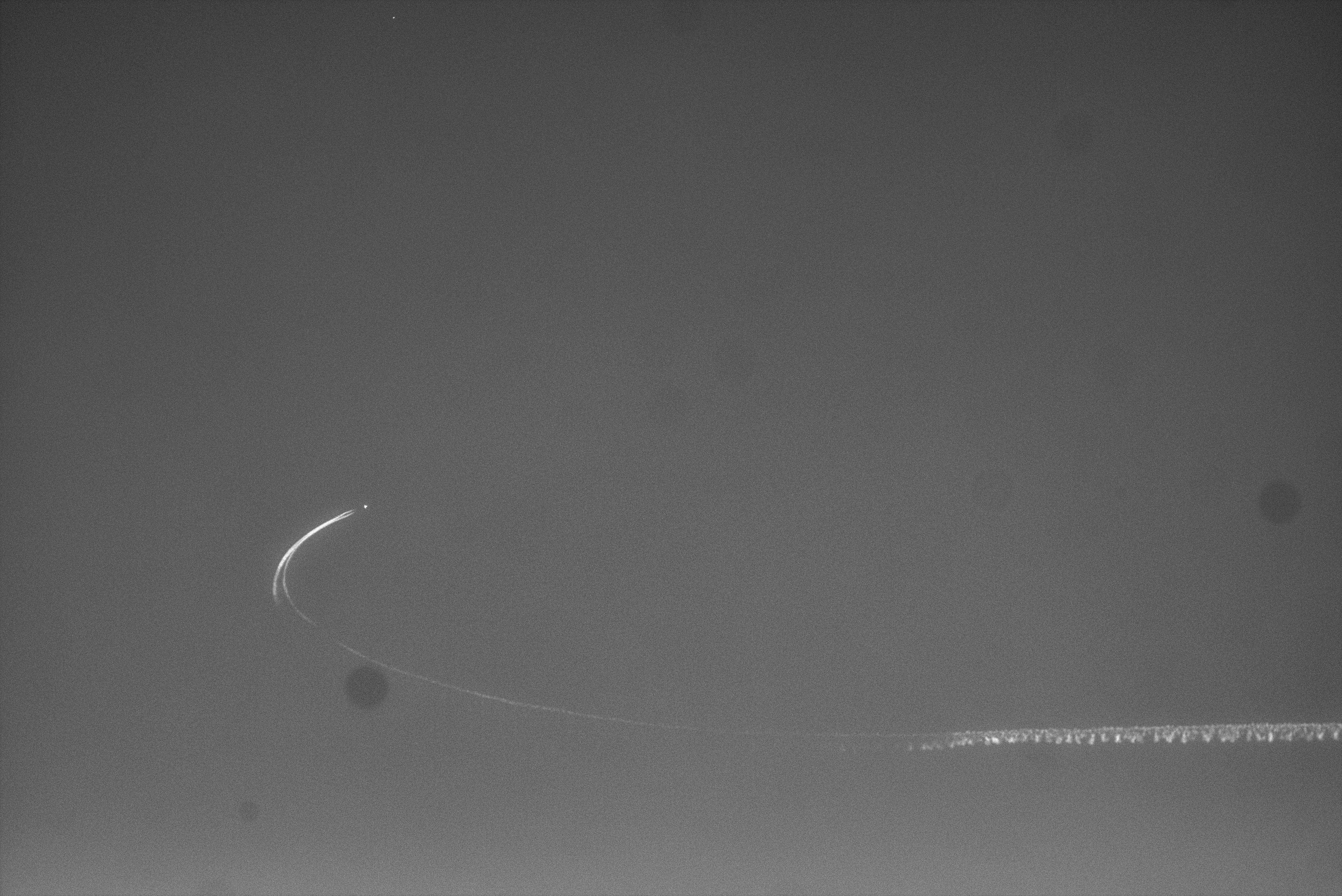 Curved Contrail over a Quiet Horizon