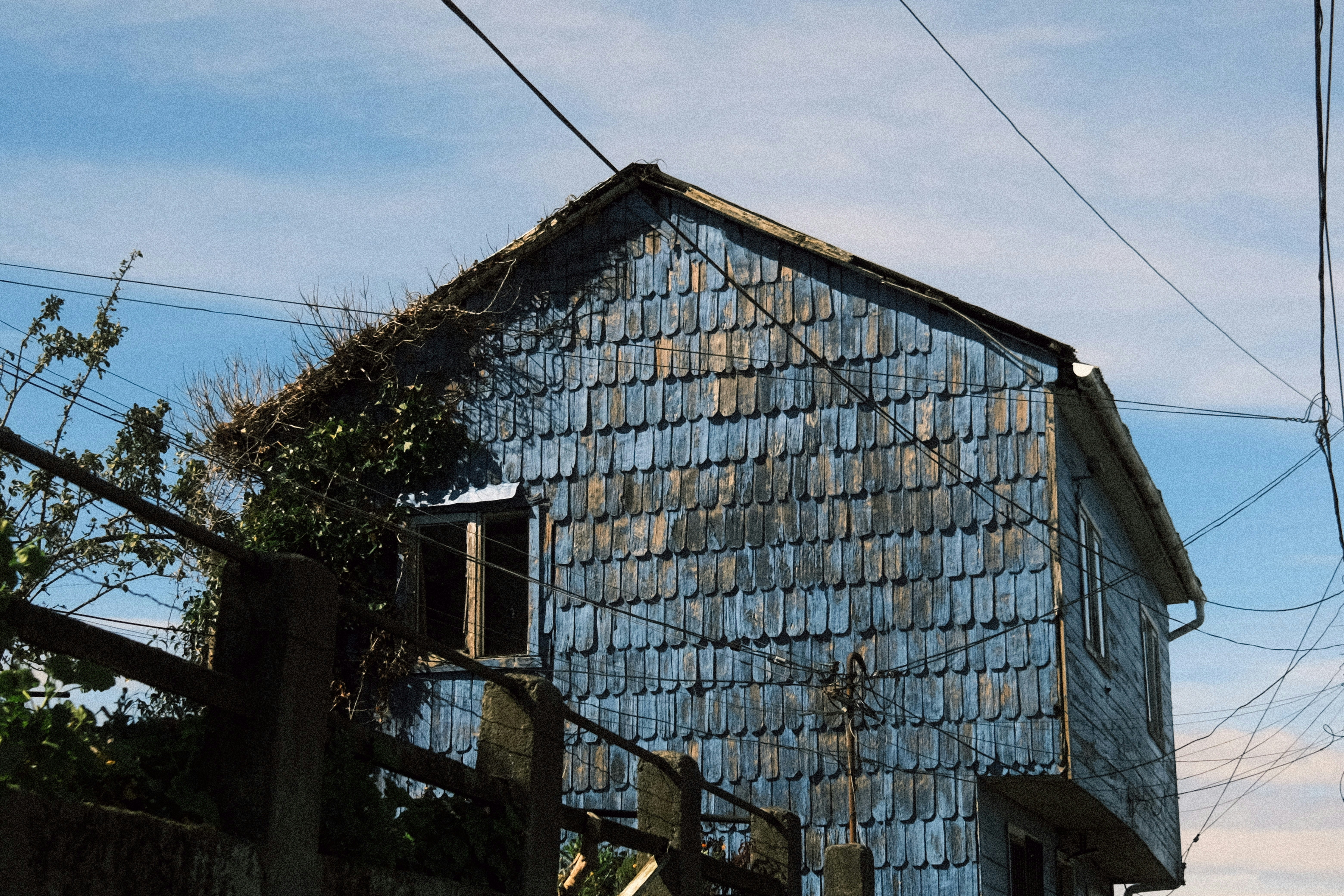 Weathered Blue Shingle House Catching the Afternoon Light