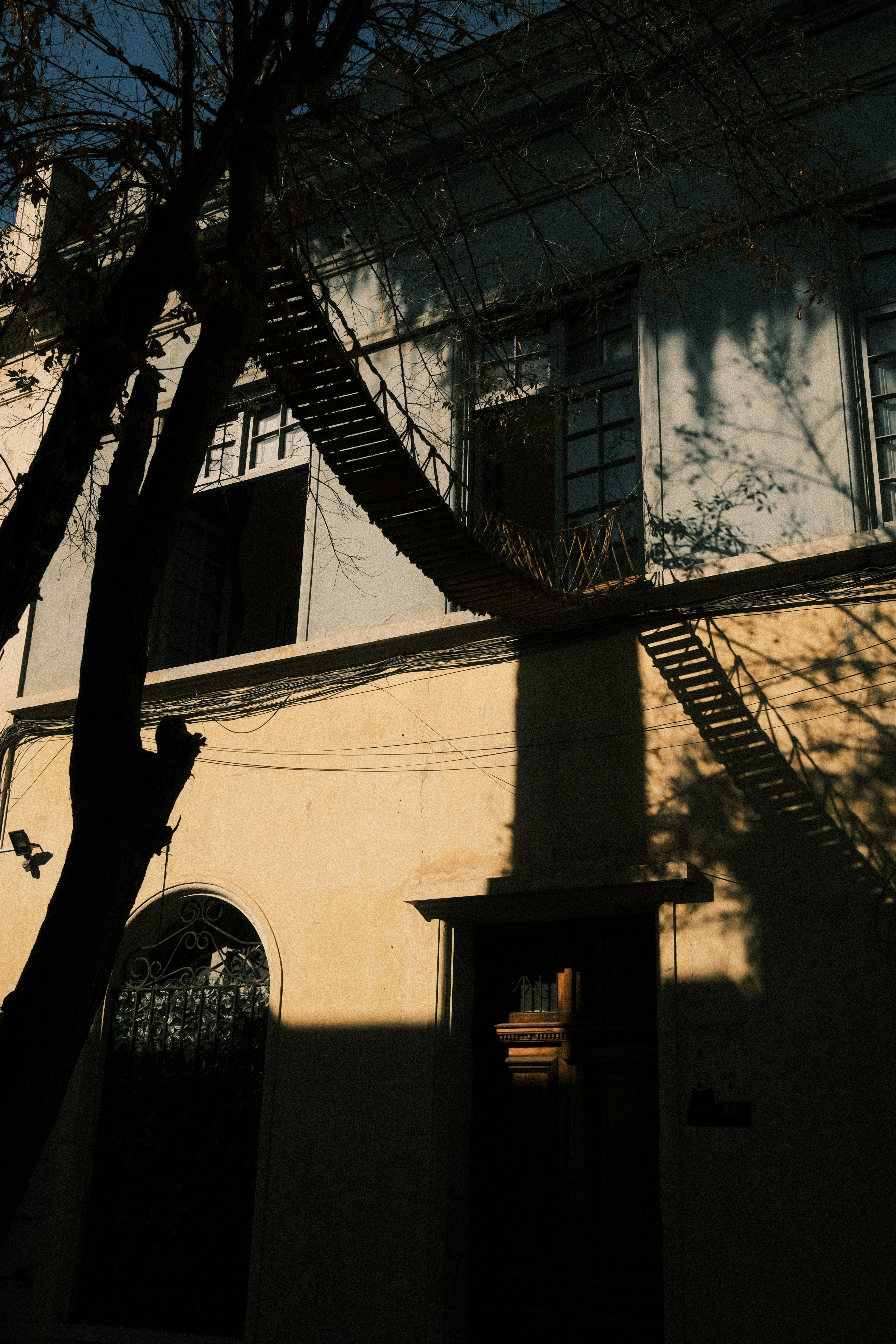 Shadowed Staircase Across a Sunlit Facade