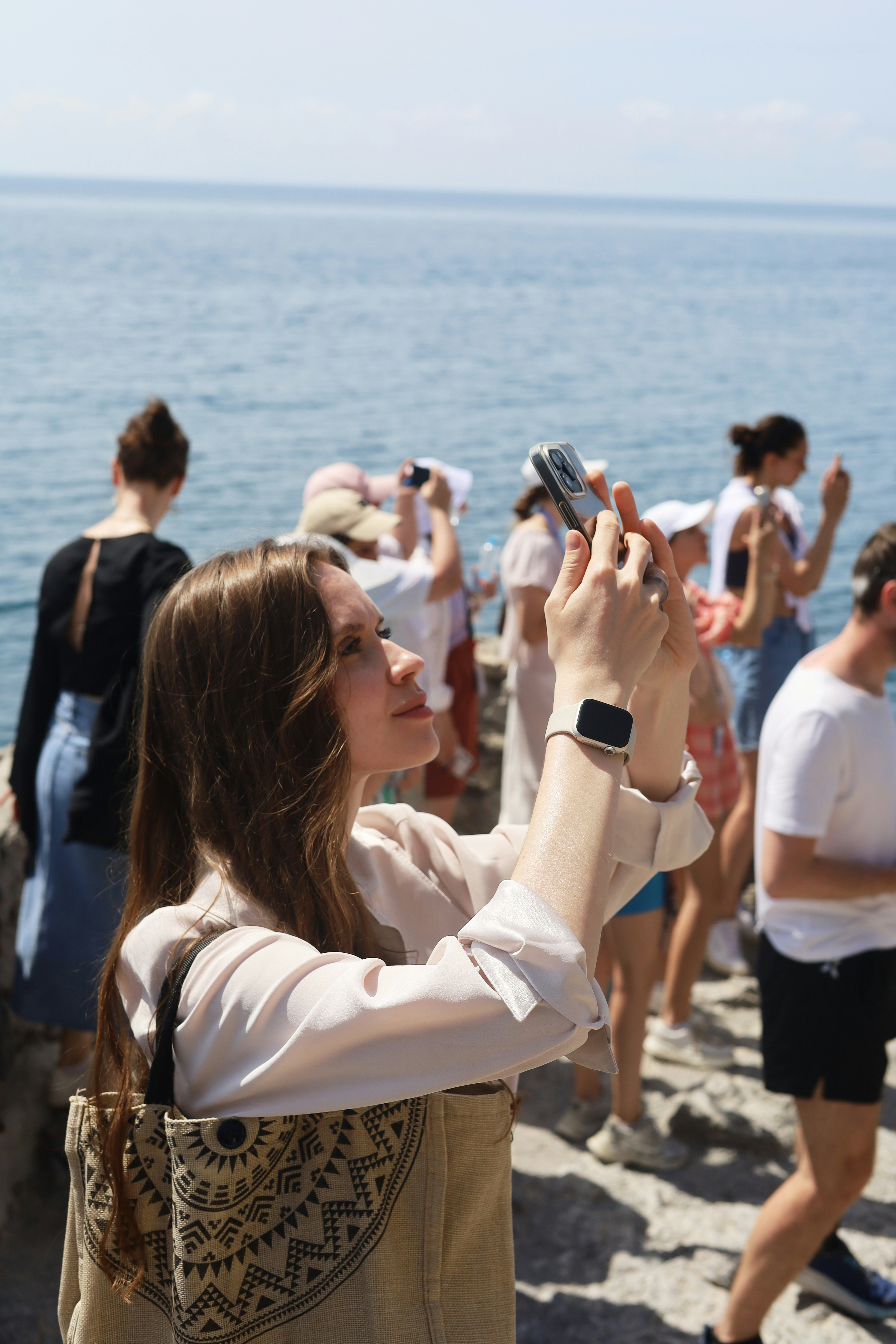 Selfie by the Sea: A Moment Captured Along the Beach Crowd