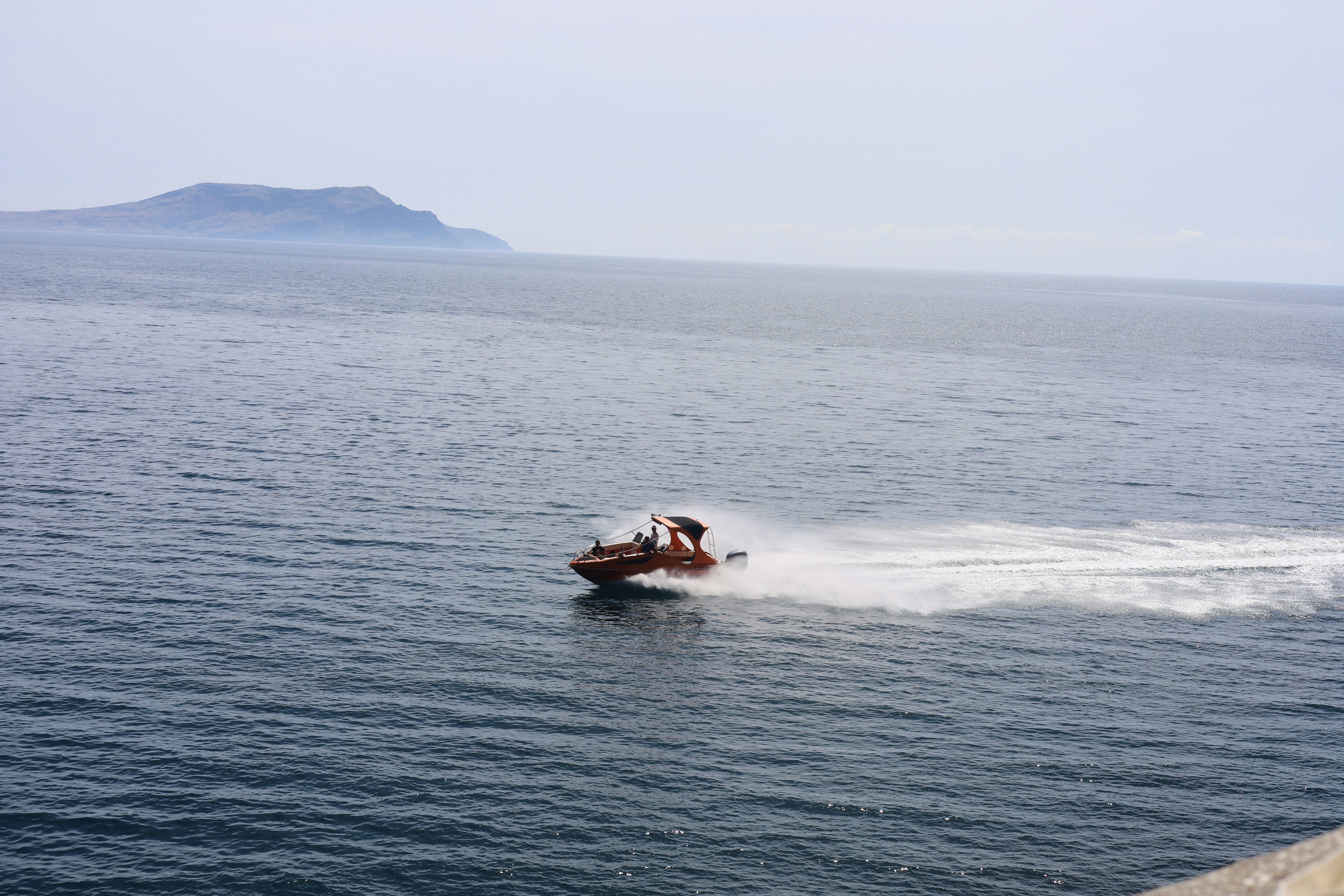 Jet Spear: A Red Speedboat Carves White Wake Across Open Sea
