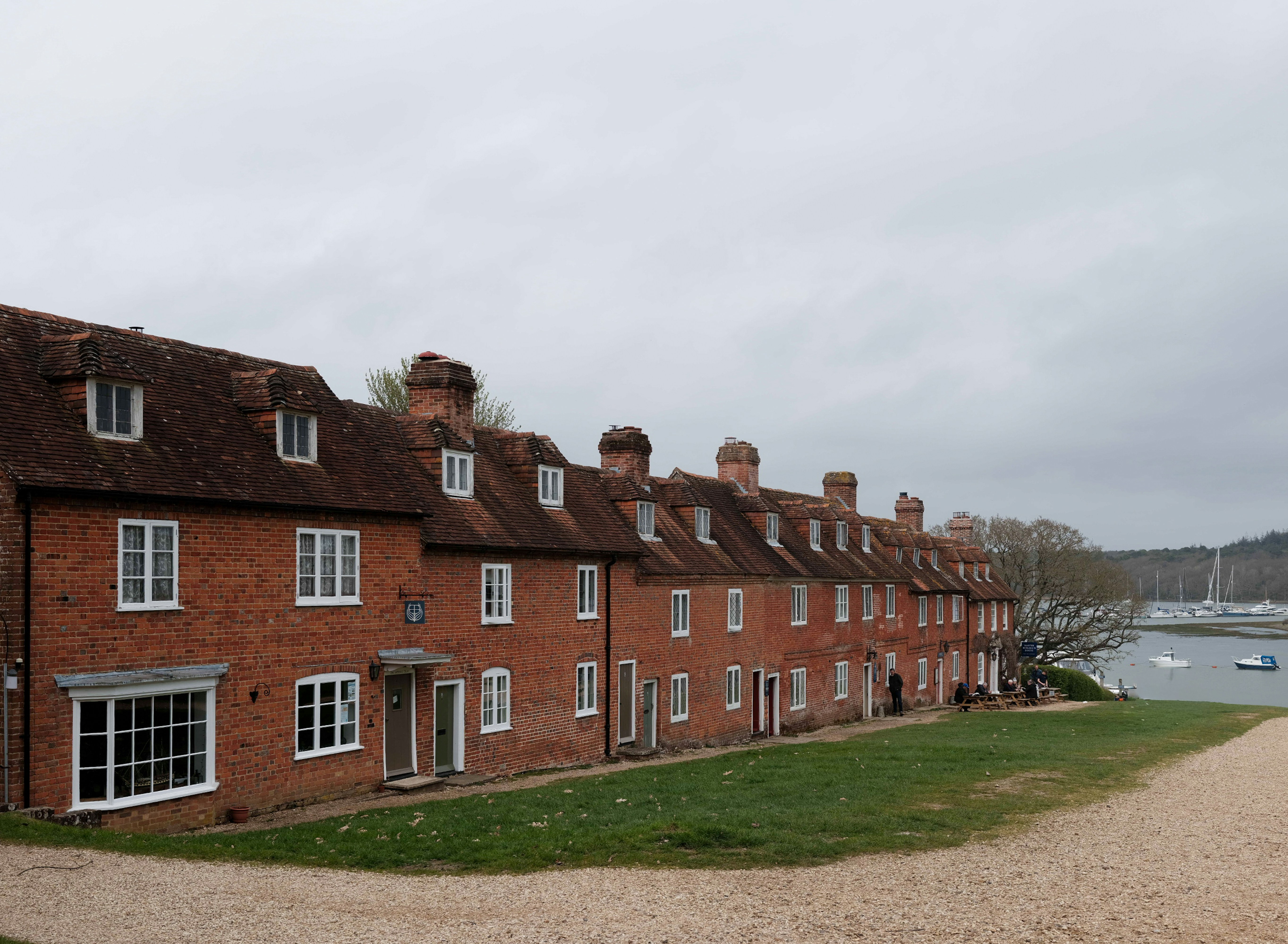 Rows of brick cottages kiss the shoreline at dusk