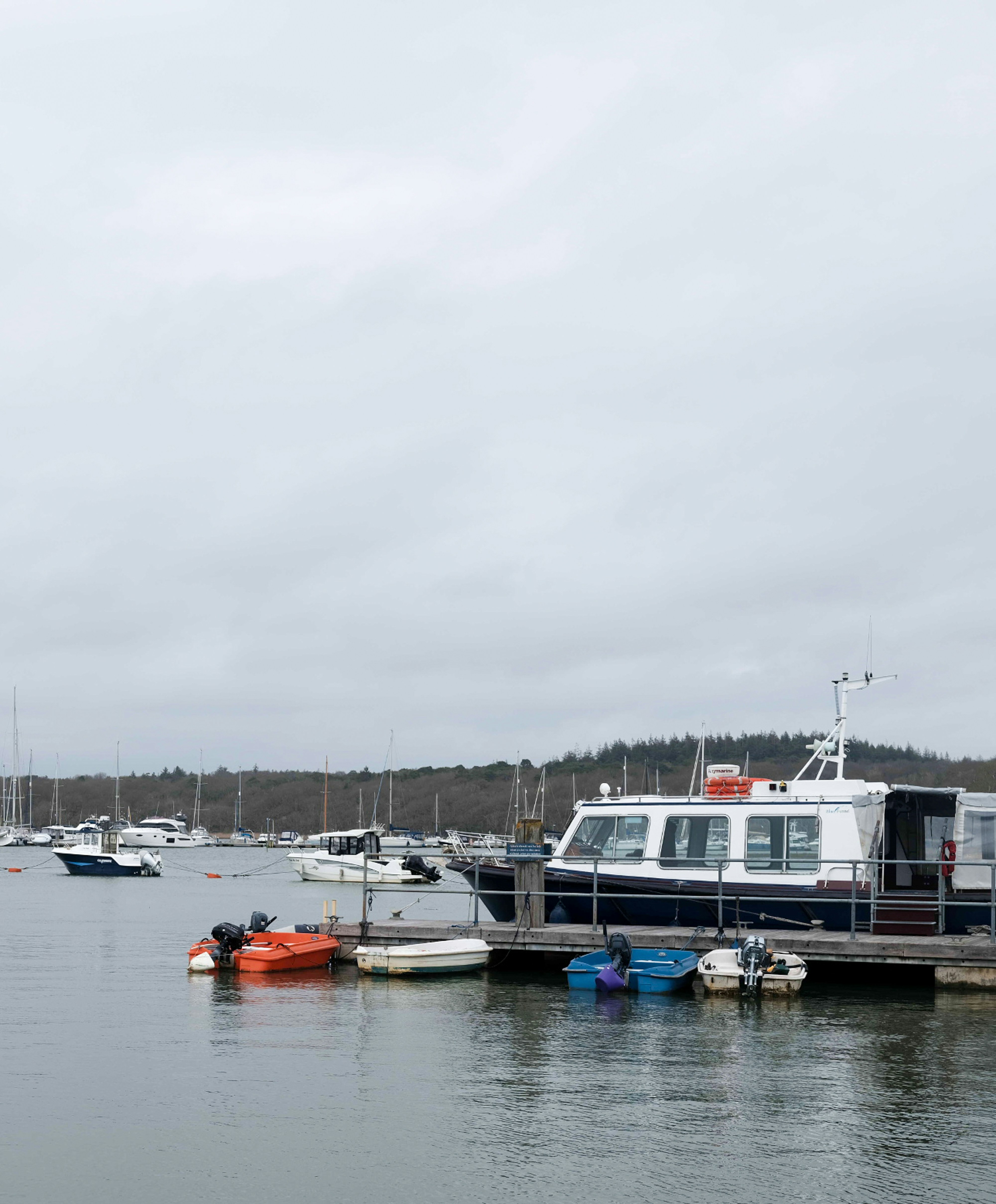 Harbor at Rest: Boats, Pier, and a Quiet Overcast