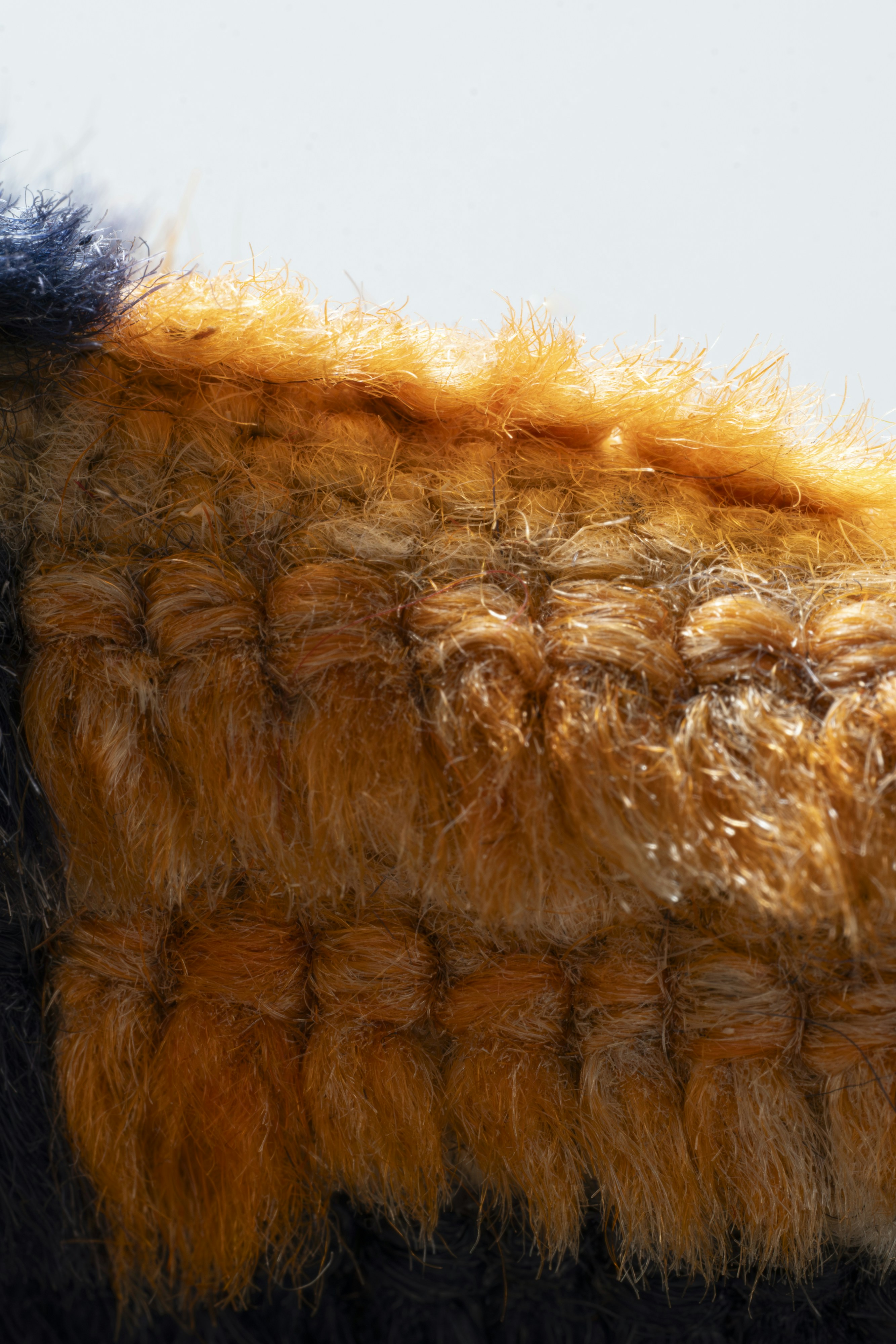 Macro View of Plush Knitted Texture in Warm Orange and Black