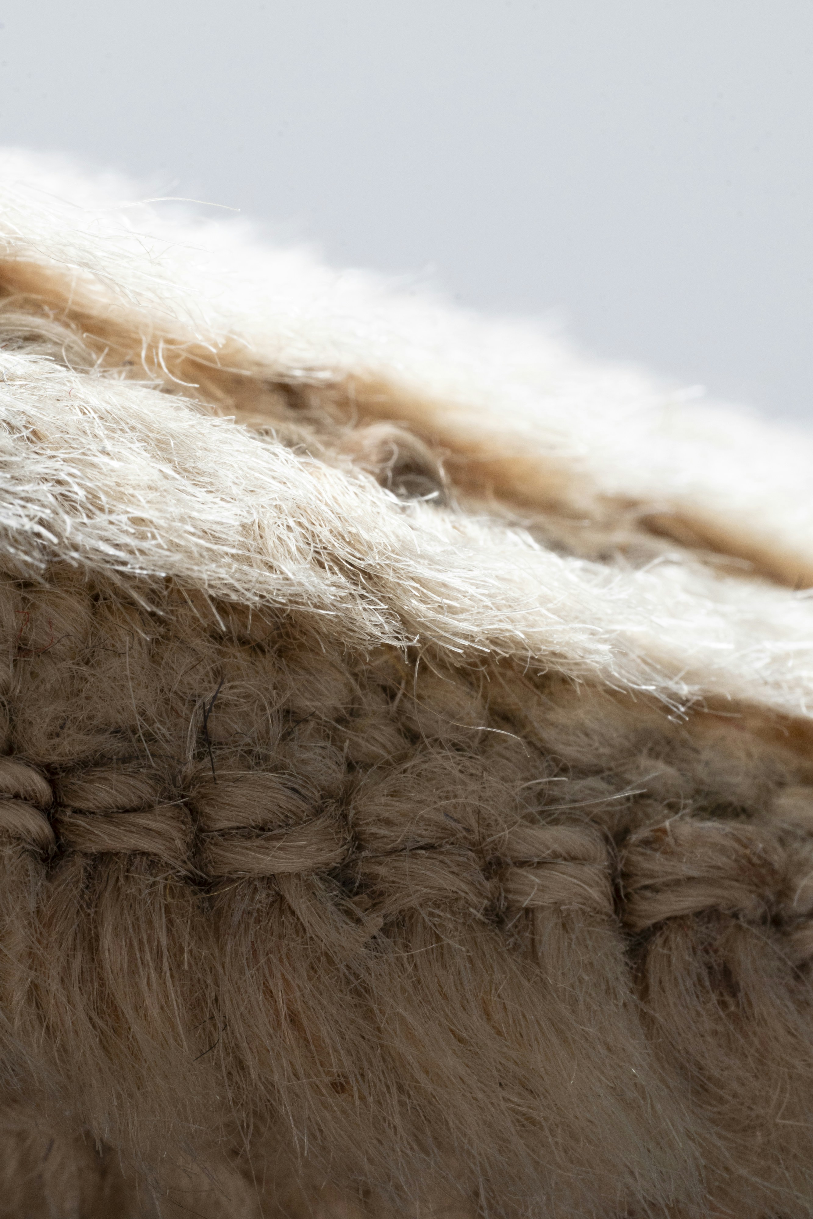 Close-Up of Cozy Fibers: A Wooly Texture Under Sunlight