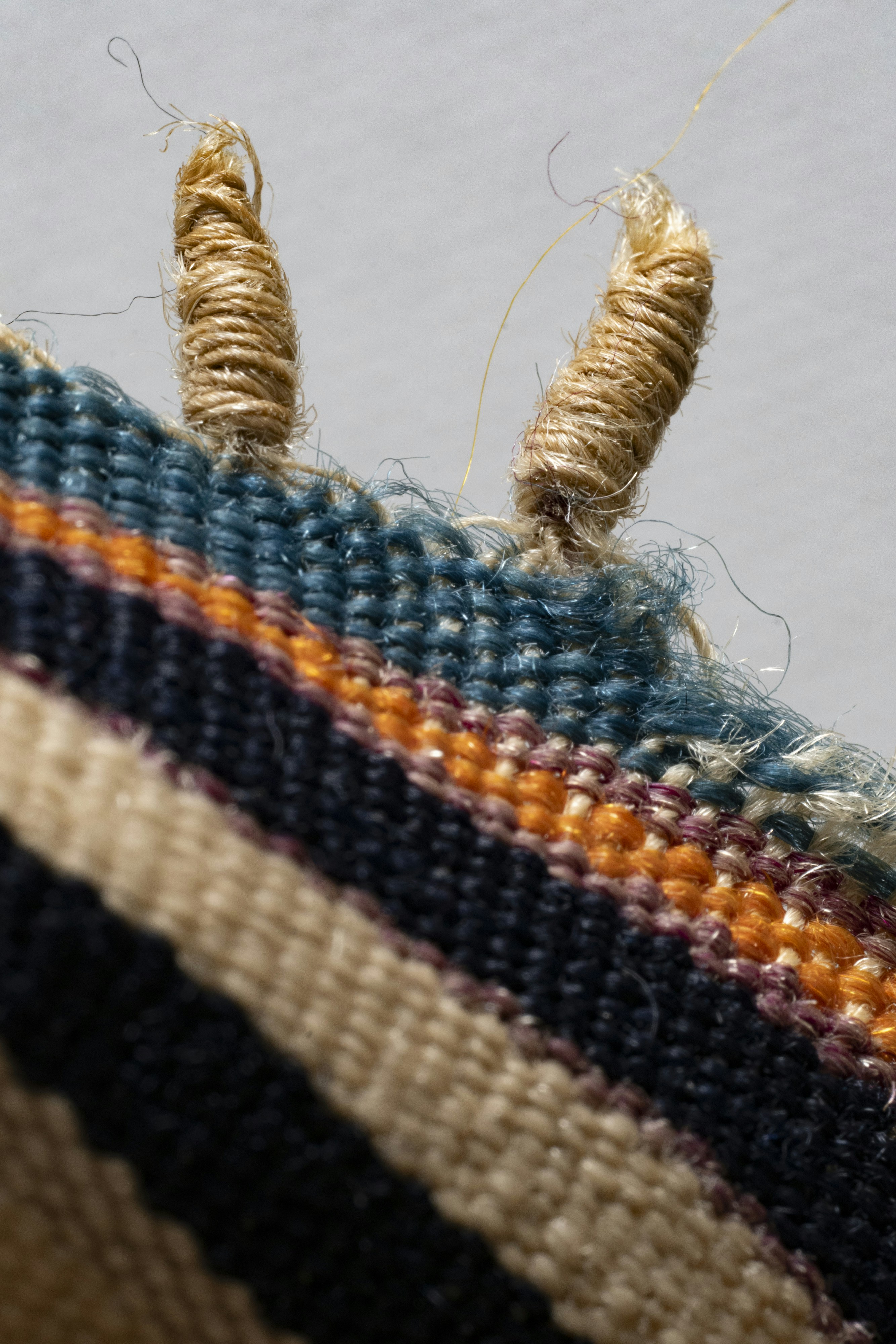 Frayed Tufts and Woven Stripes: Close-Up of a Woven Textile's Edge